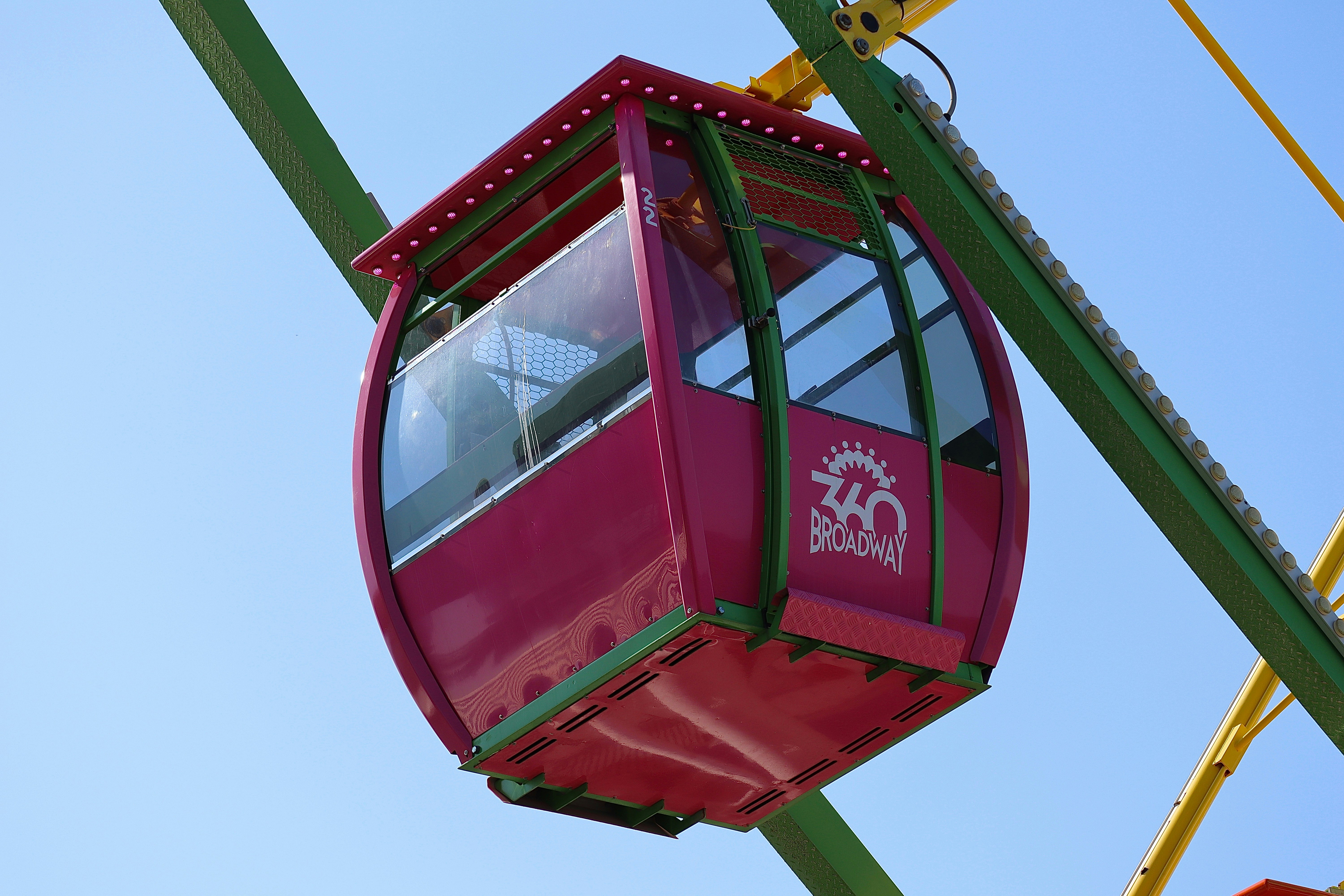 Broadway Crimson Gondola Hovering Under Lime Arches