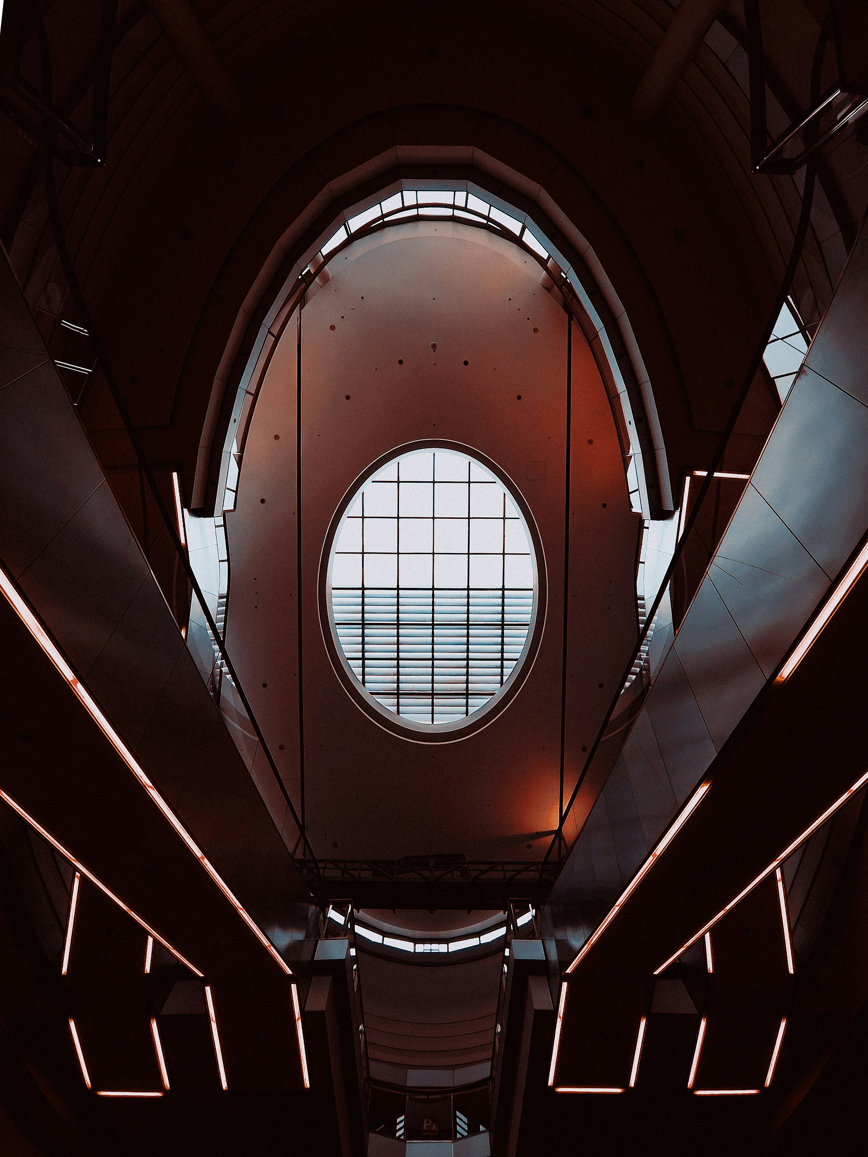 A very tall building with a big round window photo – Free Building ...