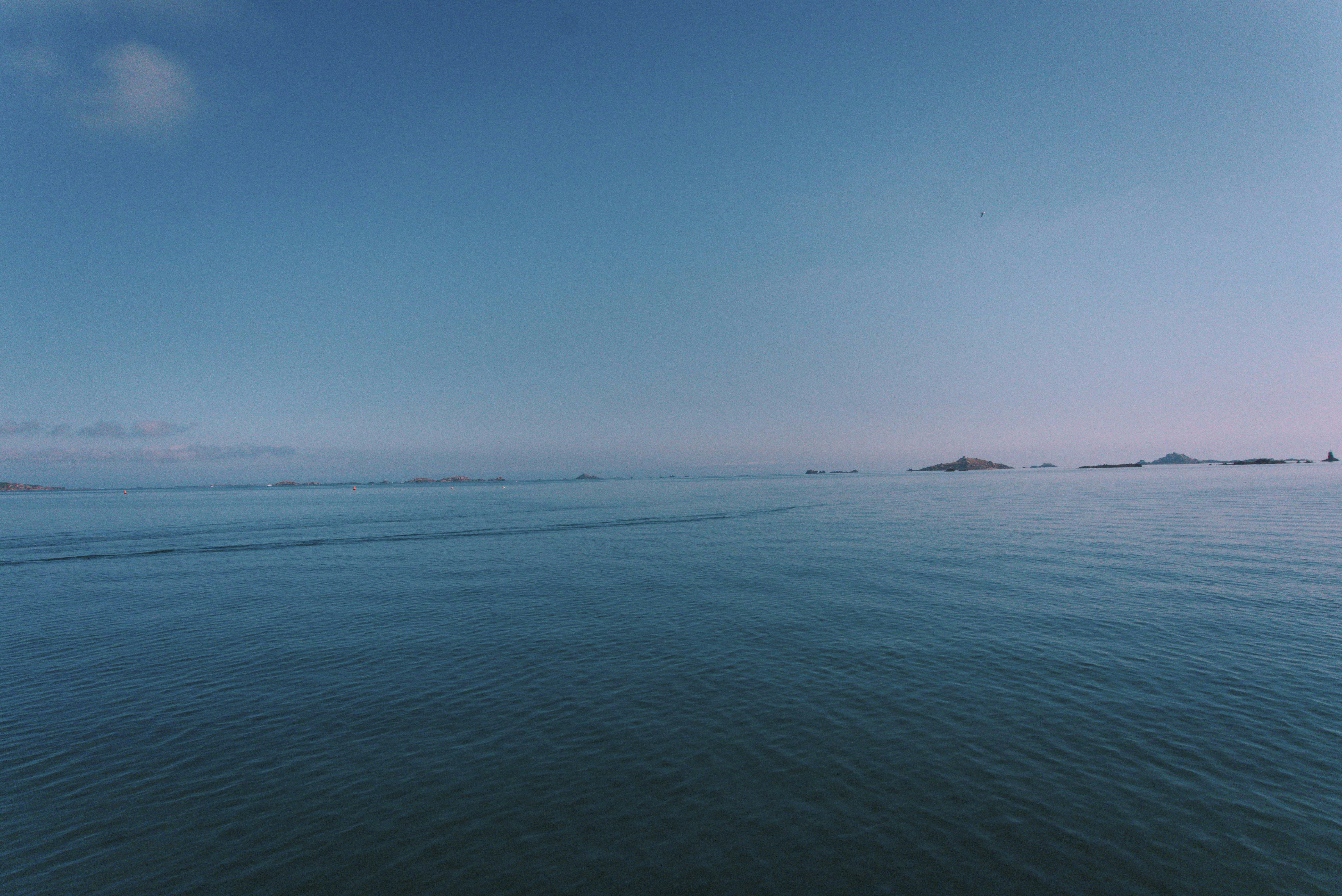 A body of water with a sky in the background