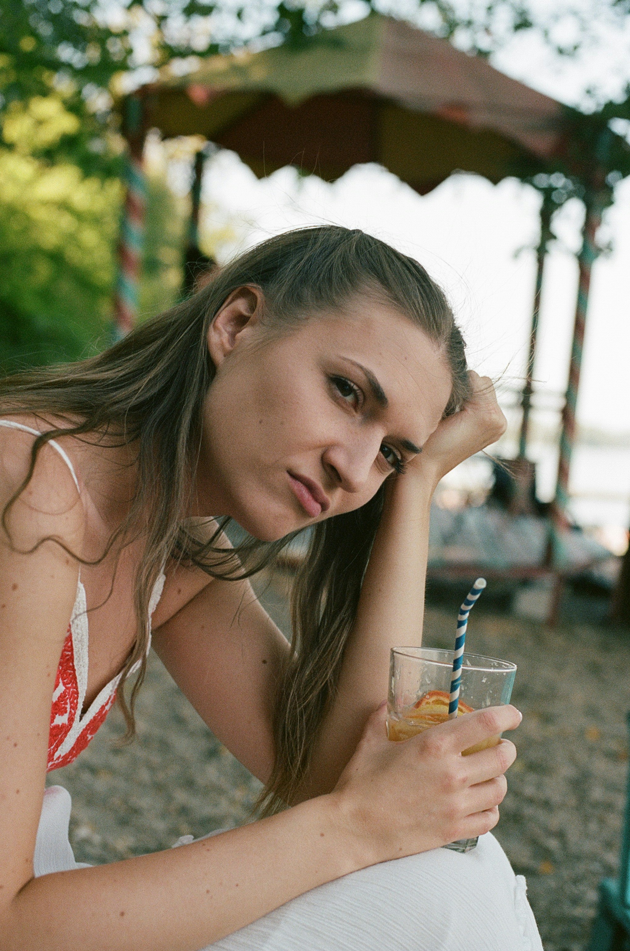 A woman sitting on a bench holding a drink photo – Free Film ...