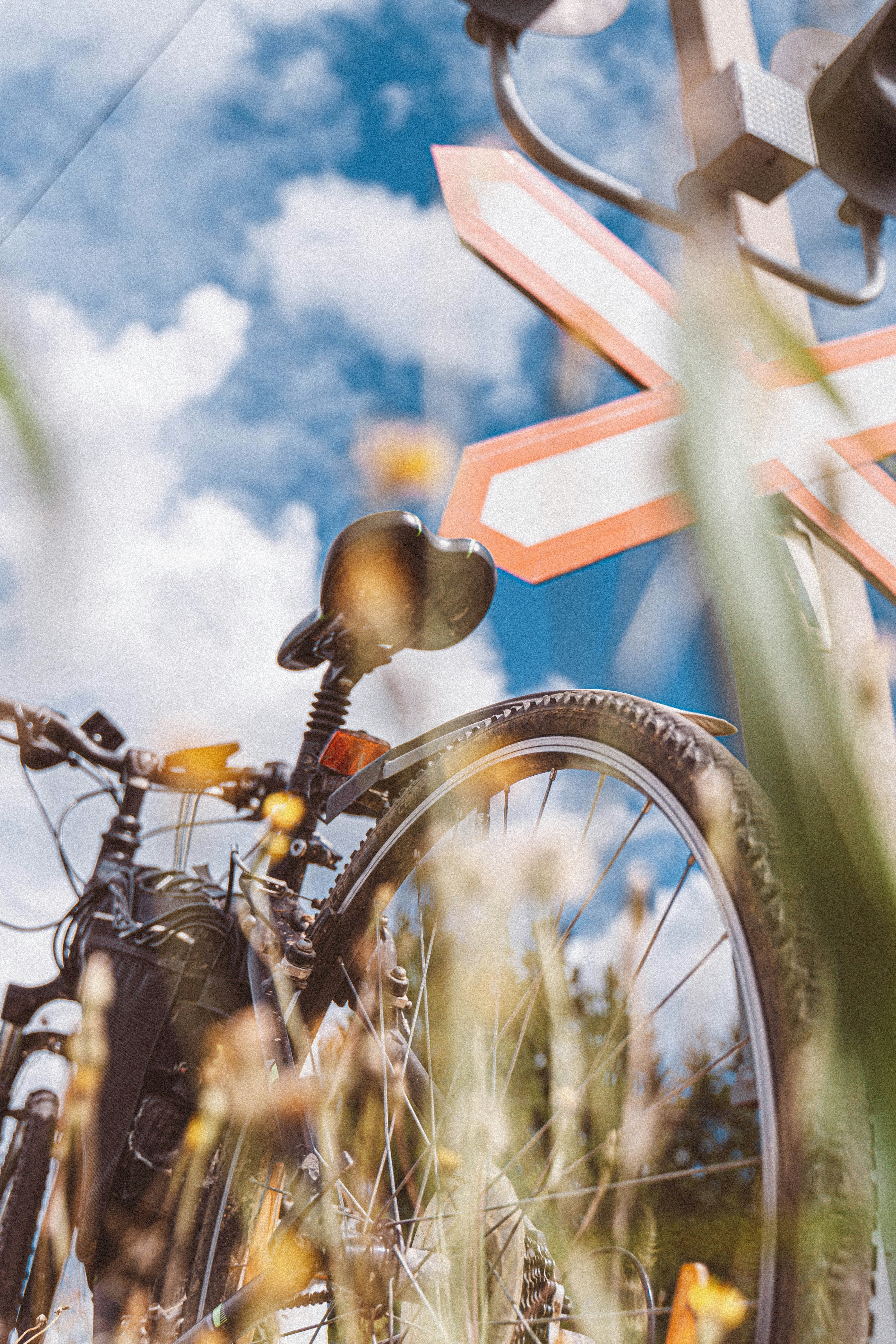 Bike in Focus: A Low-Angle City Ride Past a Sunlit Sign