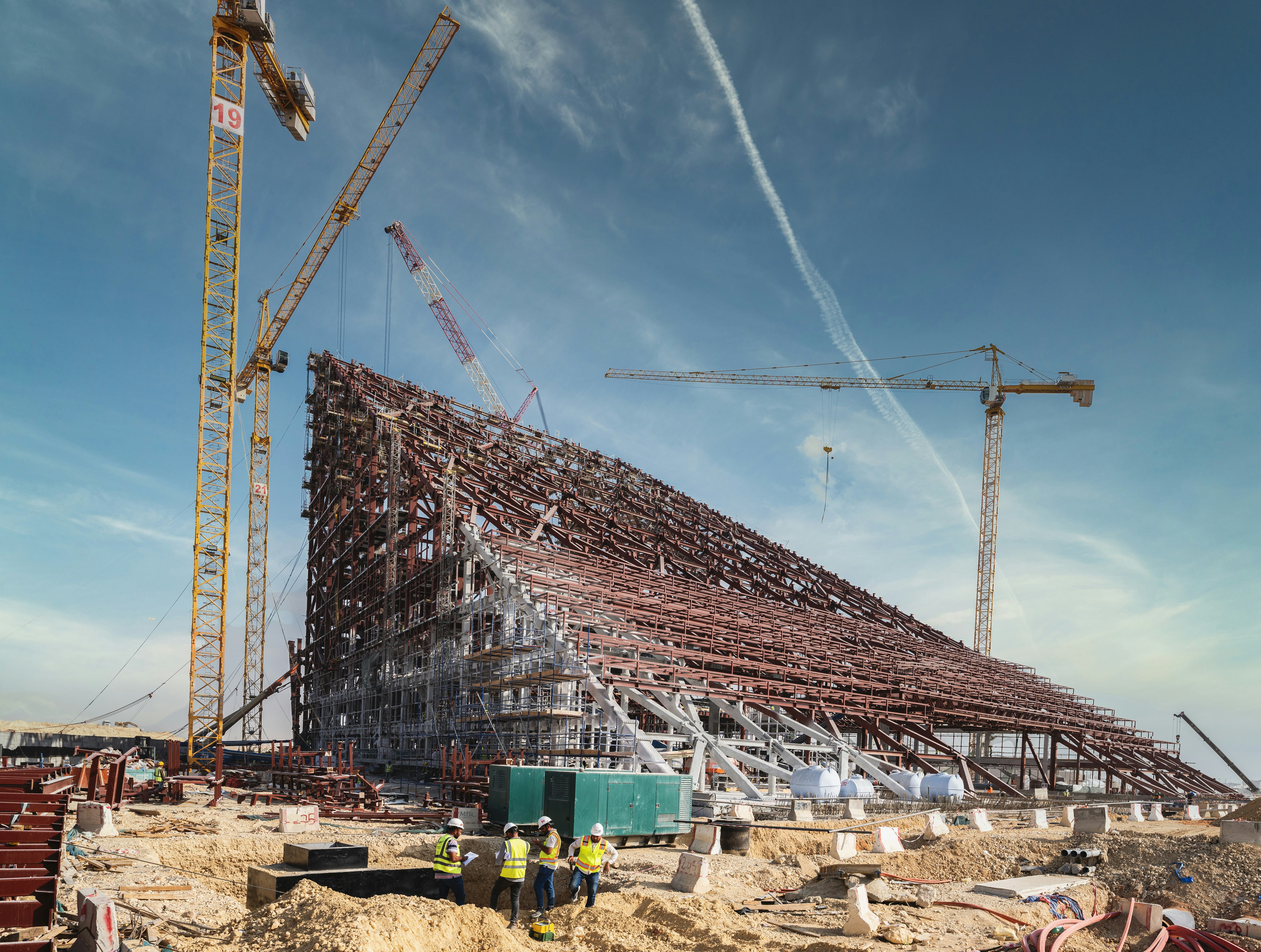 A large building under construction with a crane photo – Free Human ...
