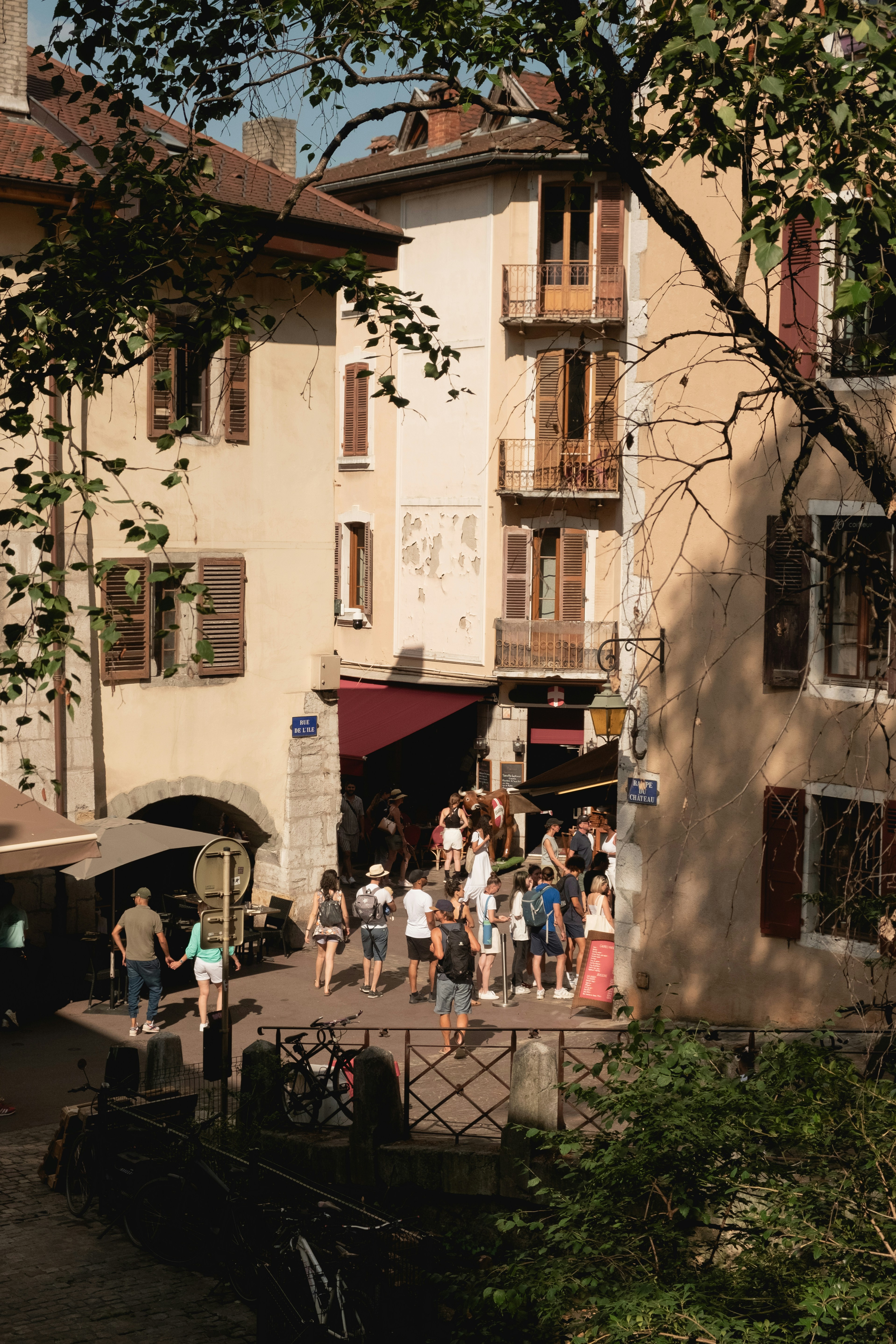 Sunlit Courtyard Confluence: A Crowd on a Narrow European Street