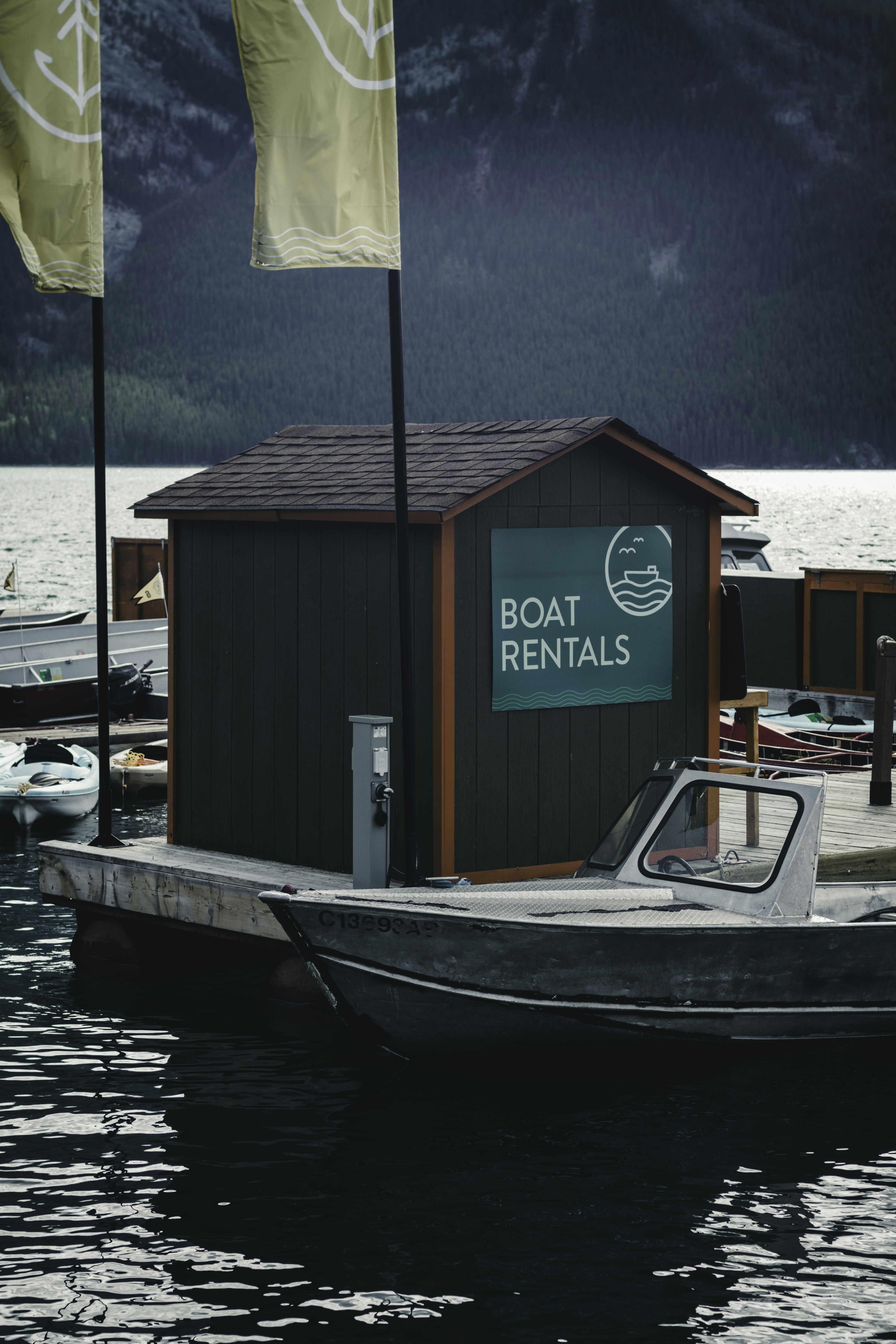 A boat is docked at a boat rental booth photo – Free Canada Image on ...