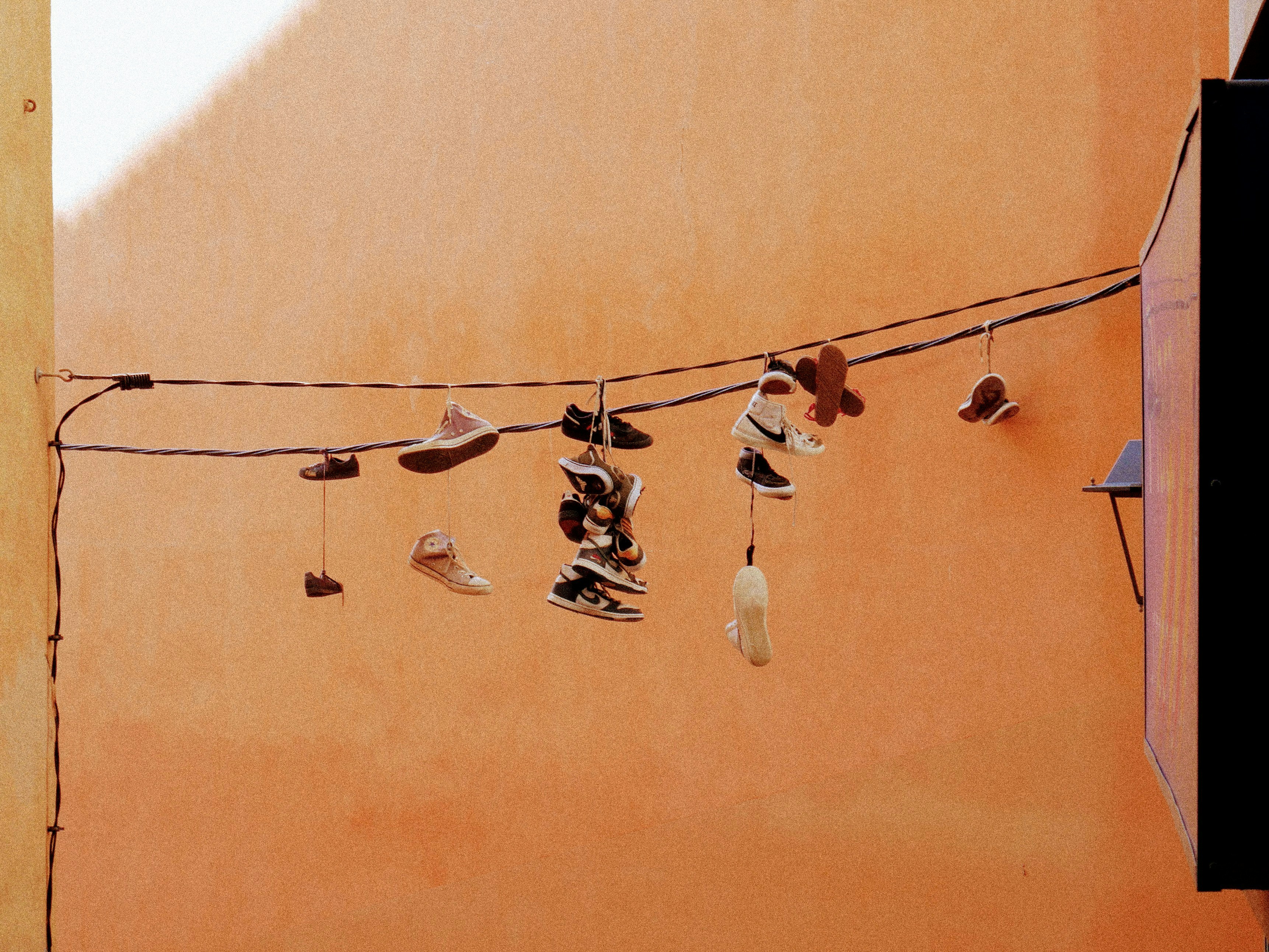 A line of shoes hanging from a clothes line photo – Free Palma de ...