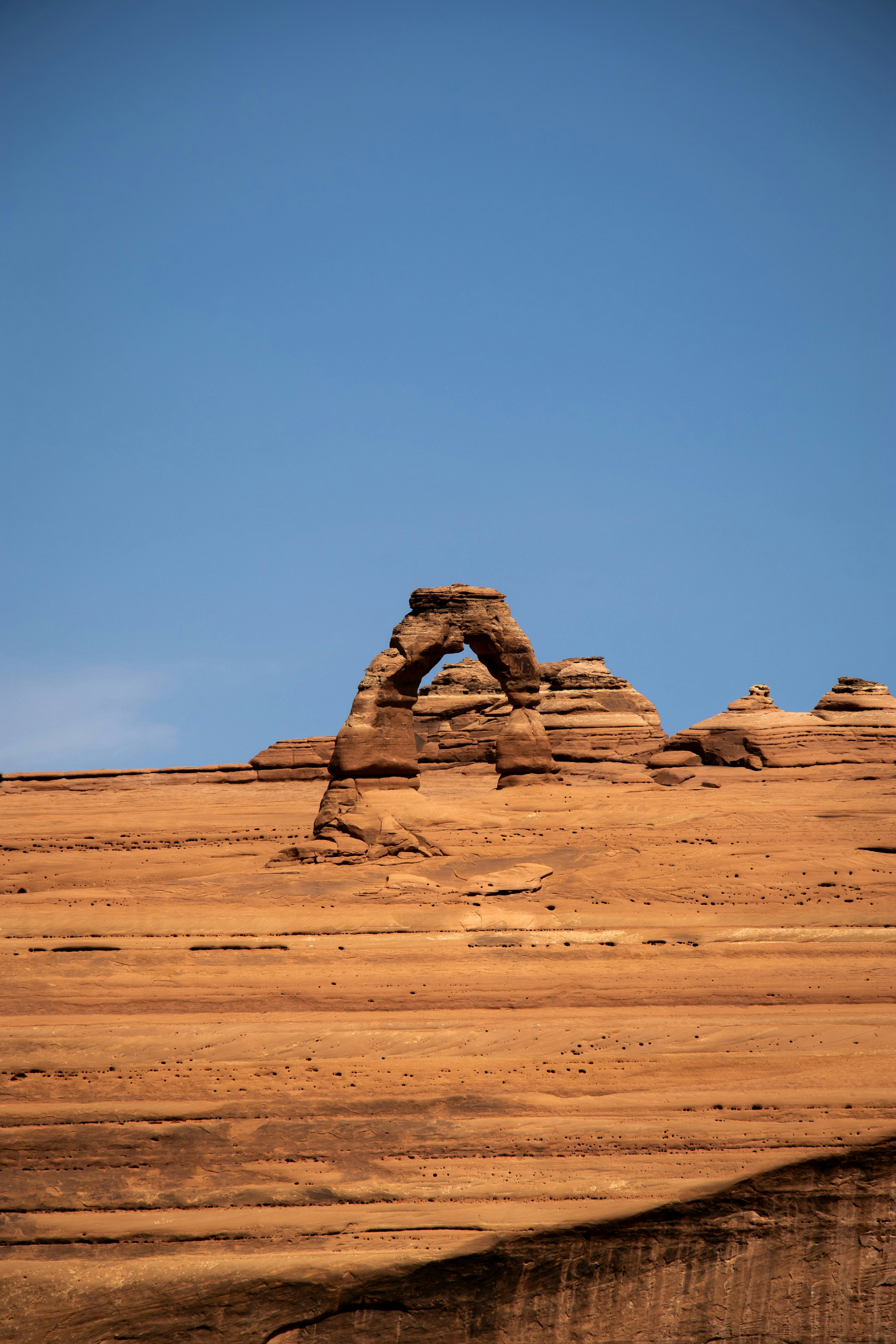 Desert Stone Arch: A Natural Gateway under a Cerulean Sky