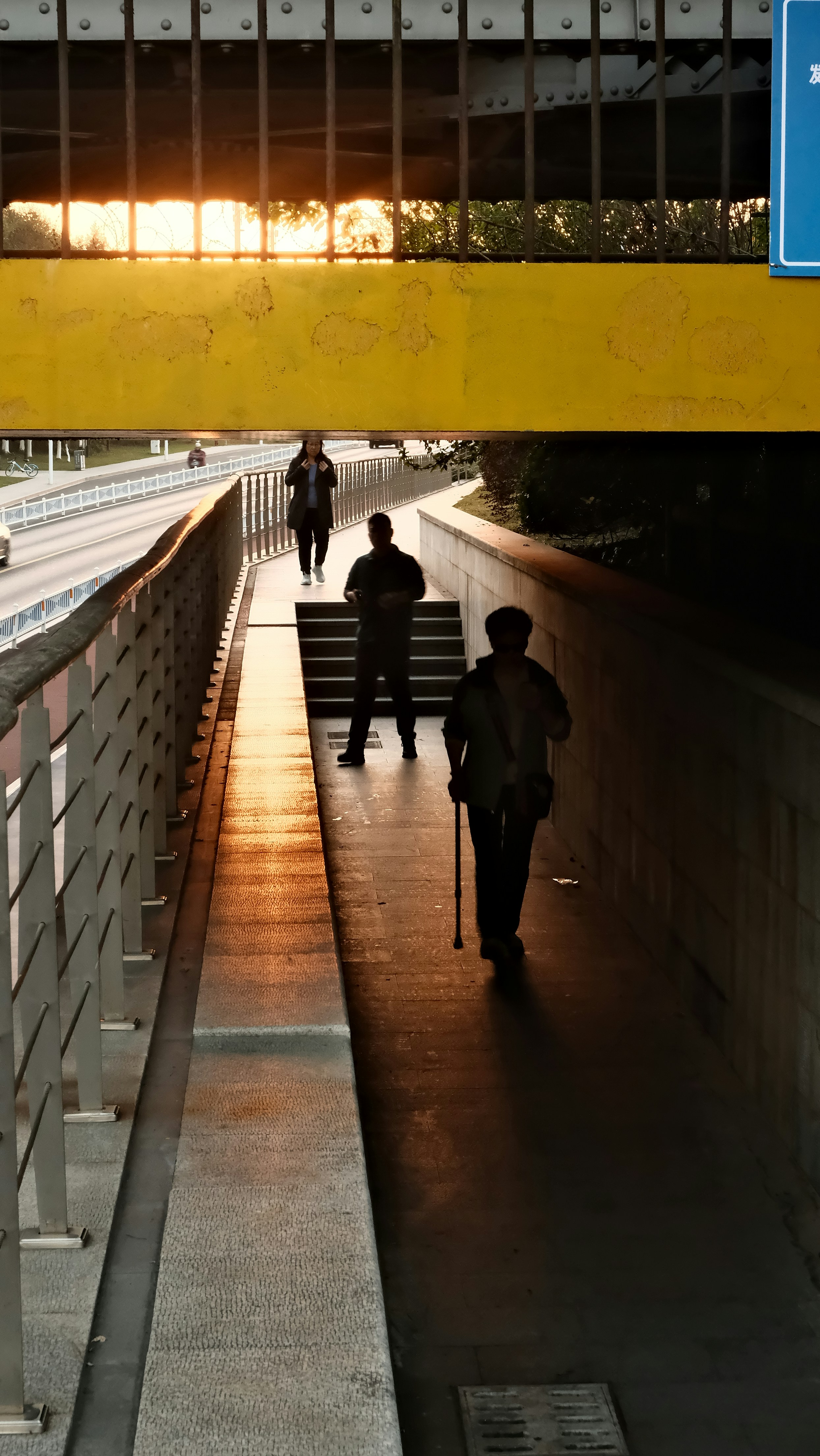 A couple of people that are walking down a bridge photo – Free China ...
