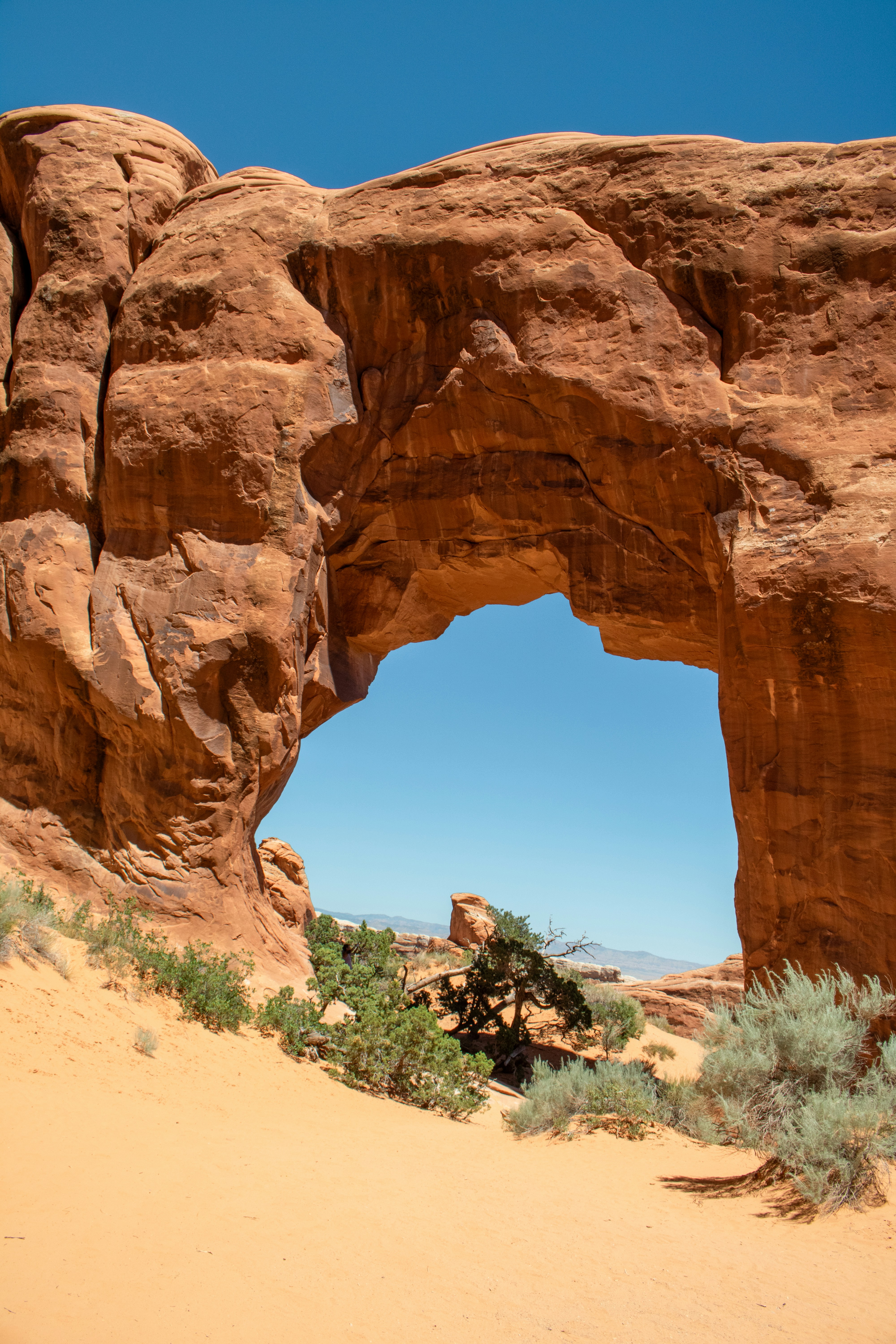 Azure Opening in Rust-Red Cliffs: Desert Arch Framing the Sky