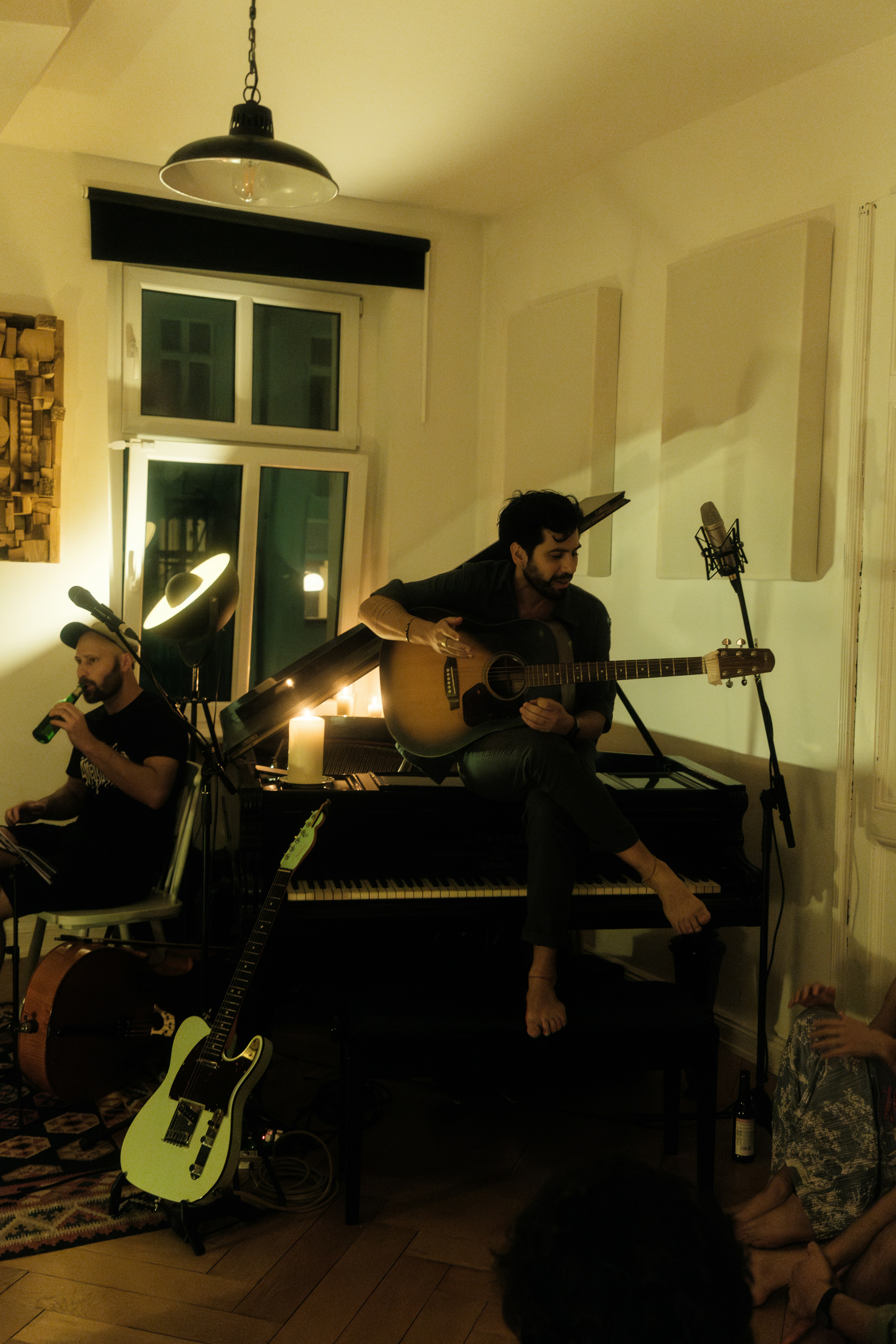 A group of people playing instruments in a room photo – Free Man Image ...