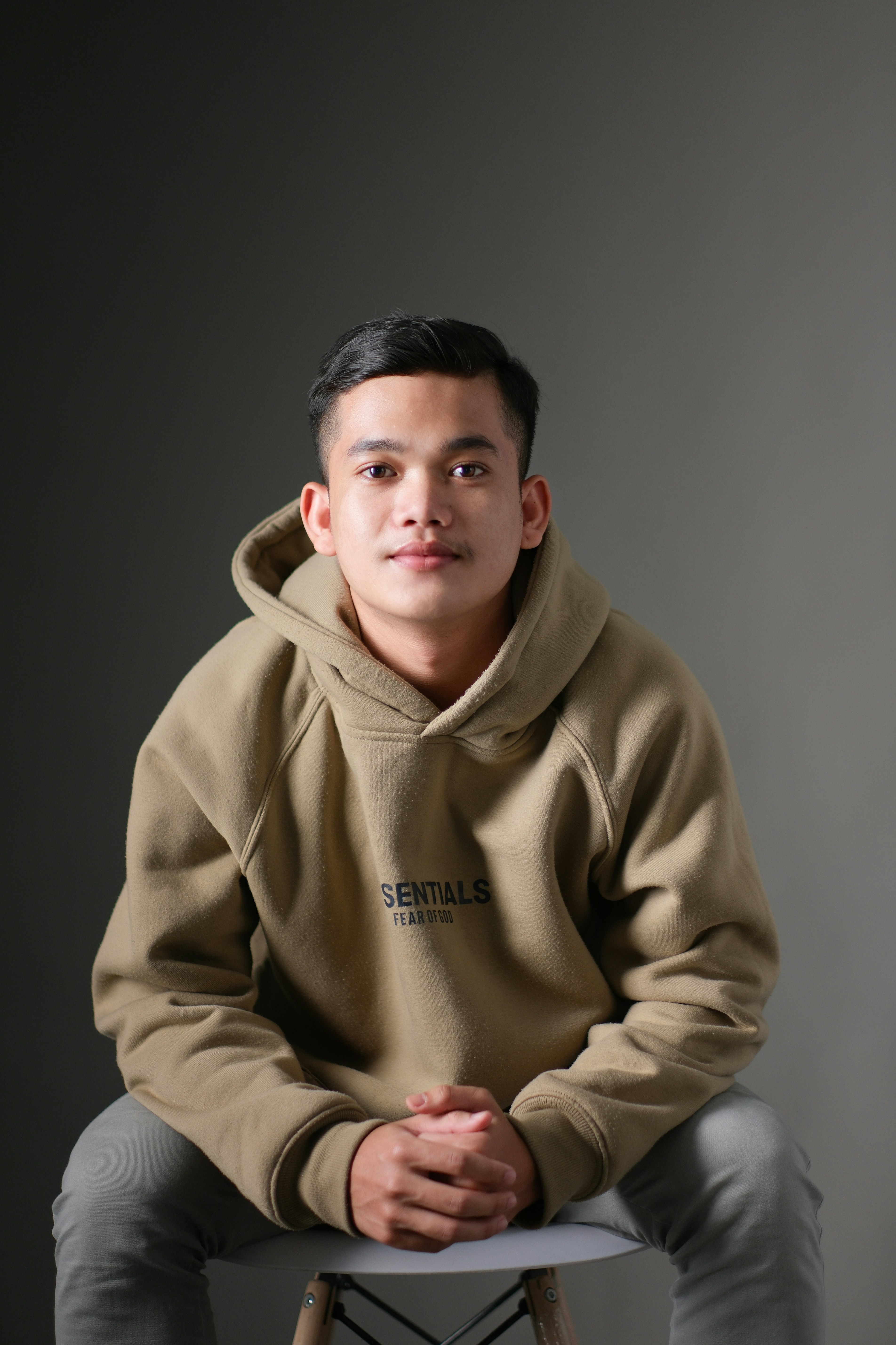 A man sitting on a stool wearing a hoodie photo – Free Face Image on ...