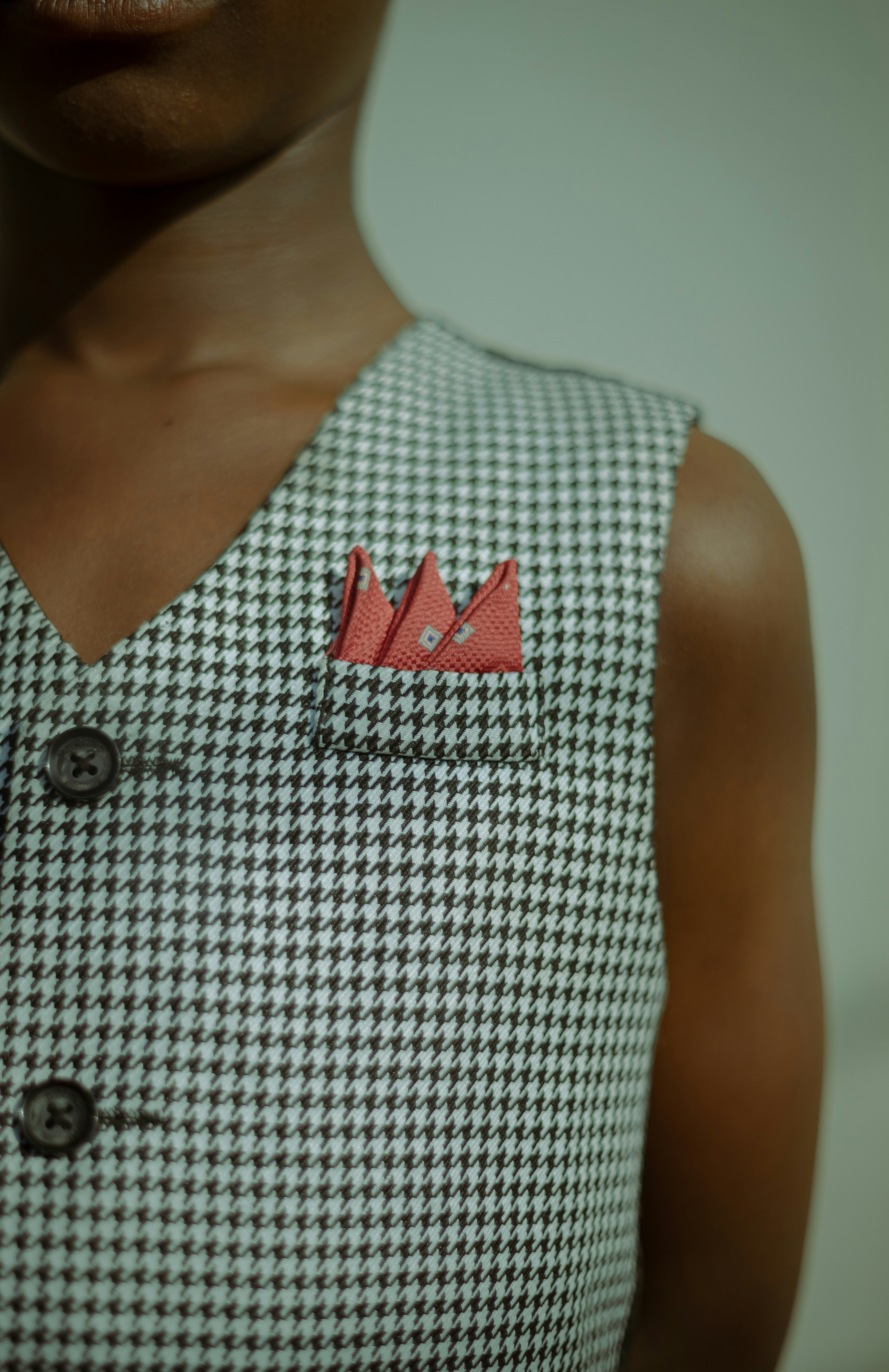 Crimson Pocket Crown Adorns a Monochrome Houndstooth Vest
