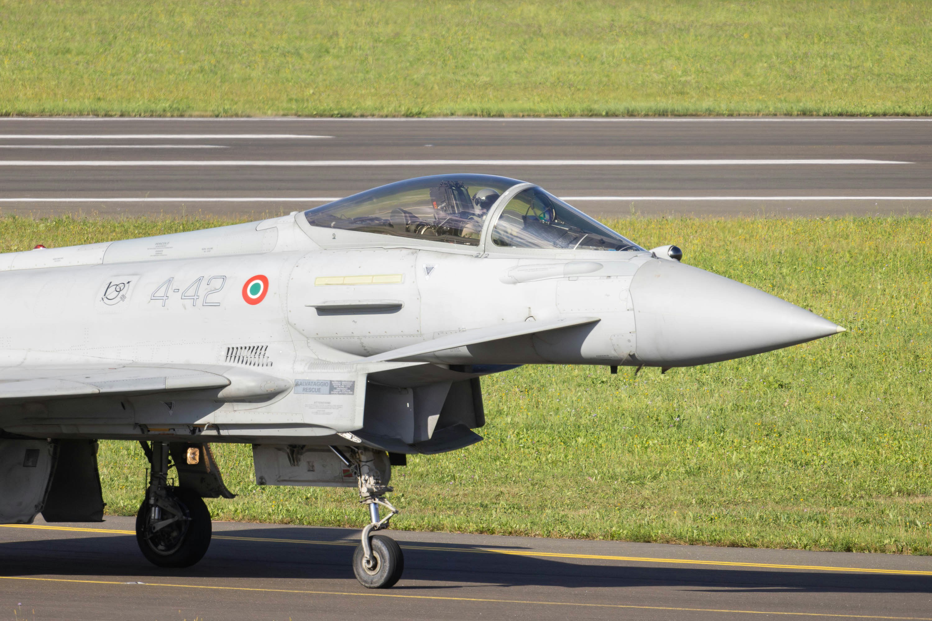 A fighter jet sitting on top of an airport runway photo – Free Aviation ...