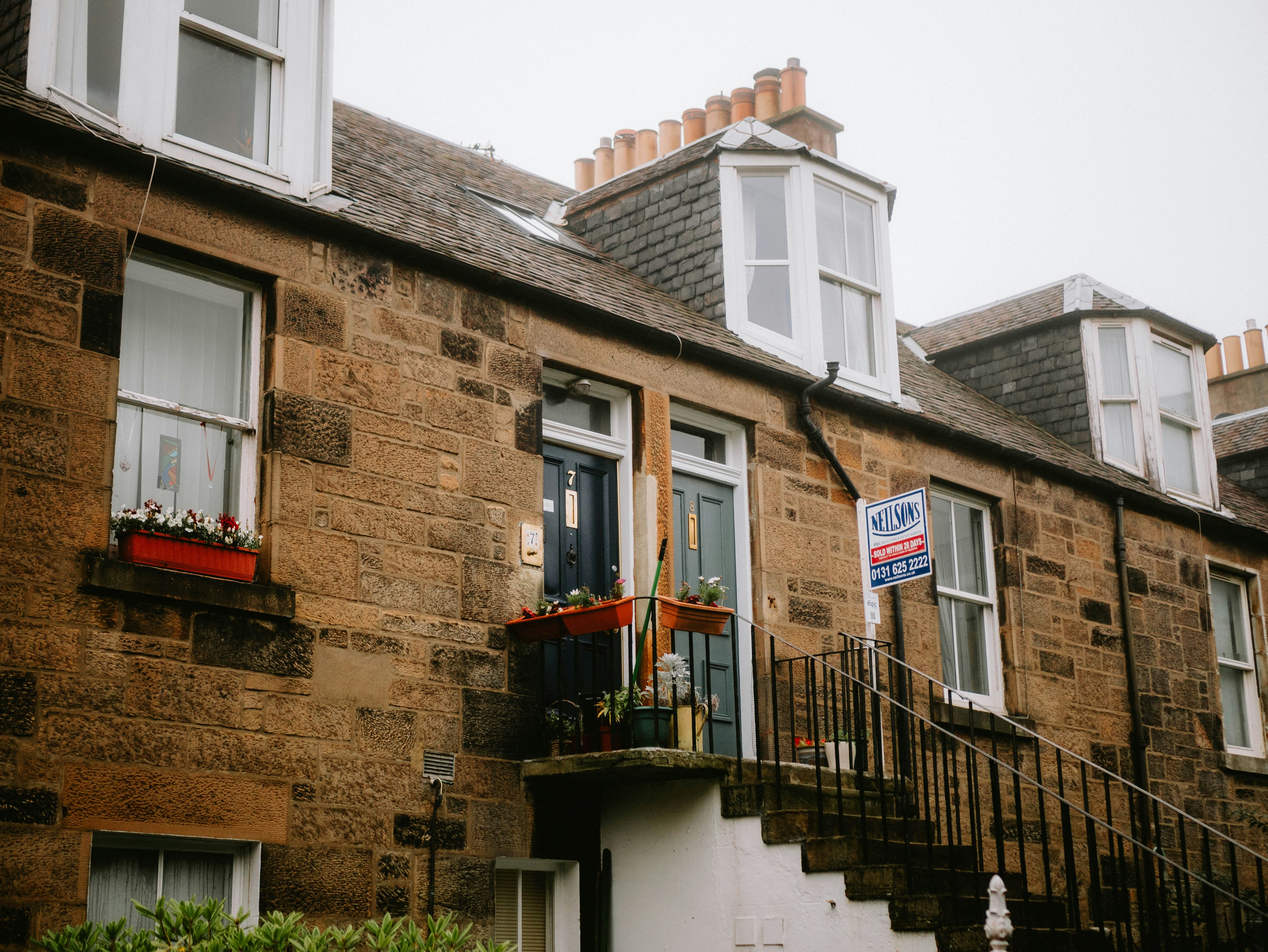 A row of brick buildings with a staircase leading up to them photo ...