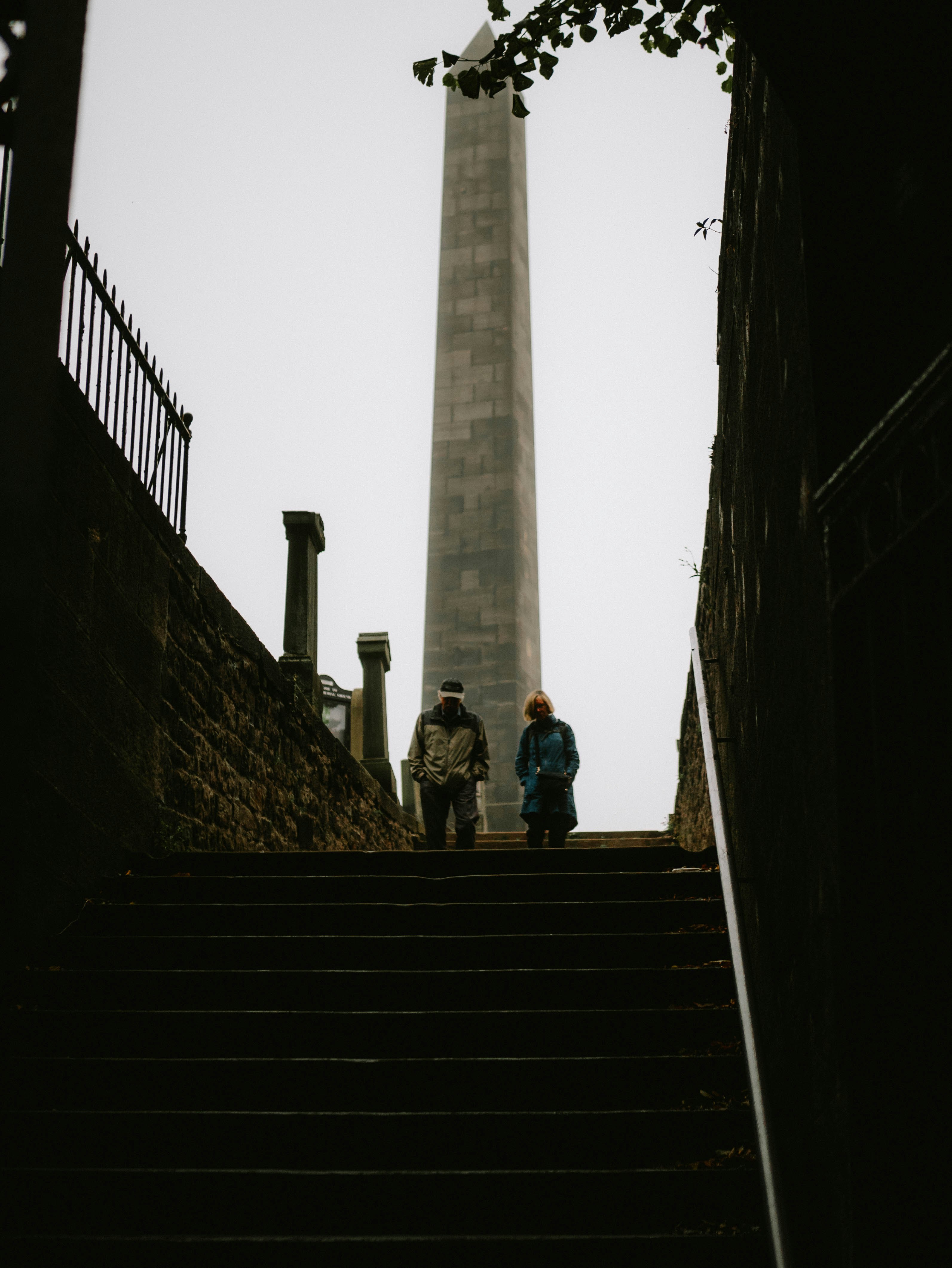 Two Wanderers at the Foot of a Silent Obelisk