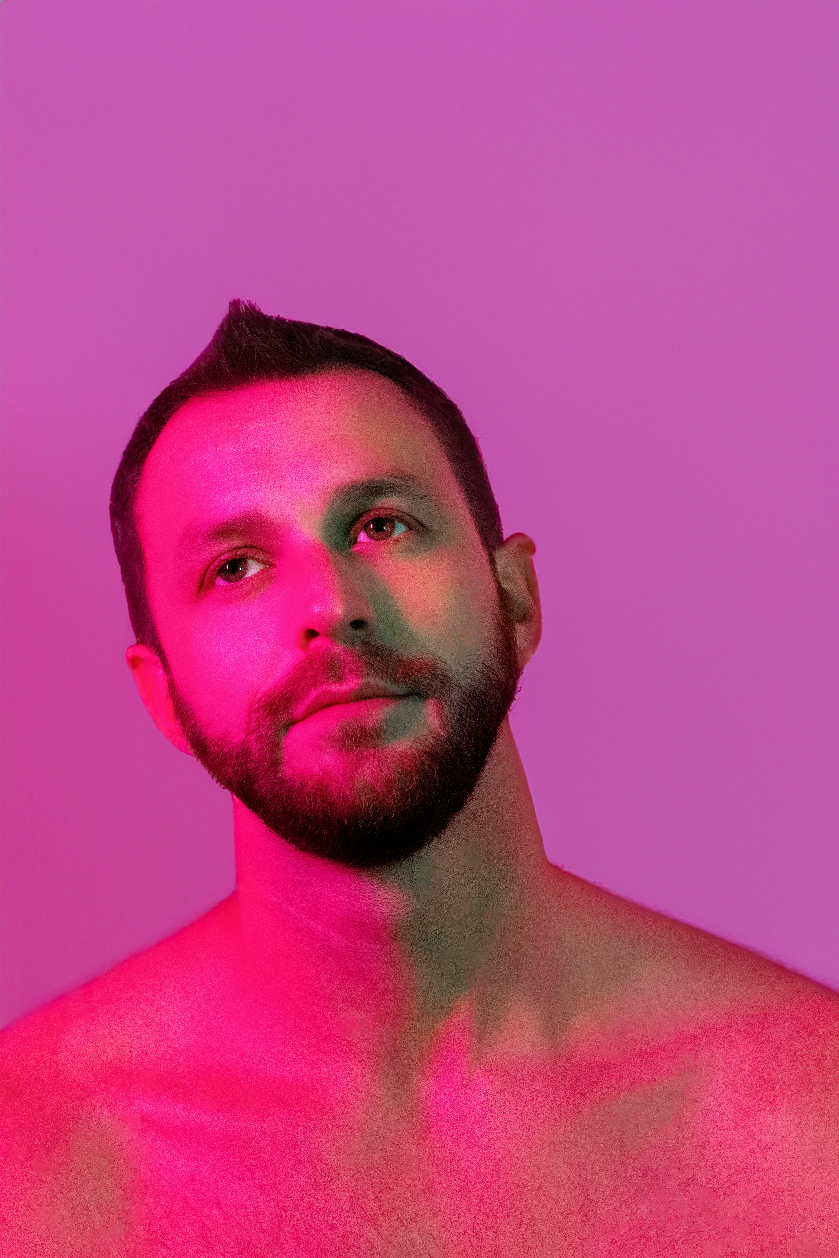 Magenta Reverie: A contemplative portrait under neon pink light