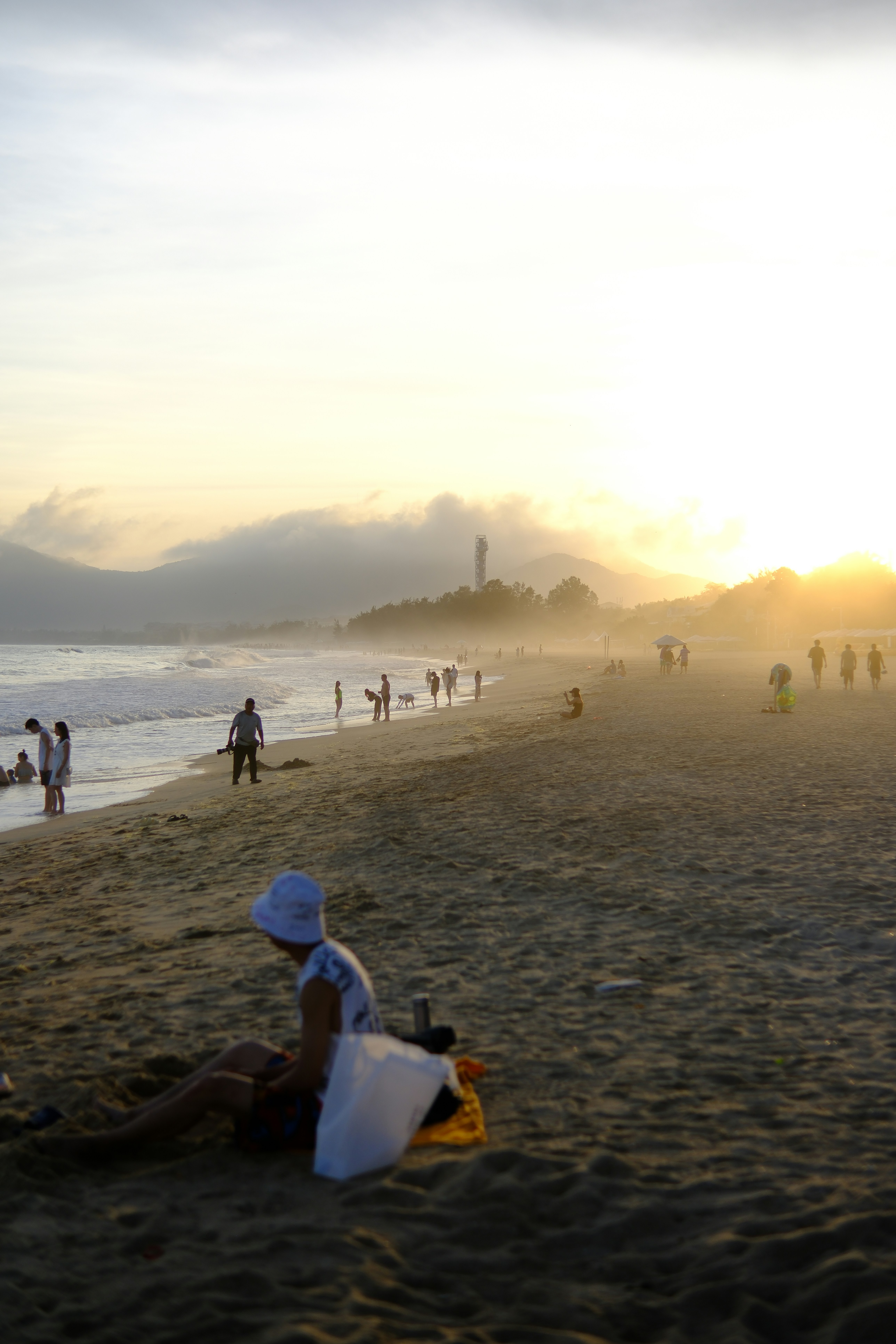 Golden Hour Solitude: A Beachgoer Resting at the Edge of Day