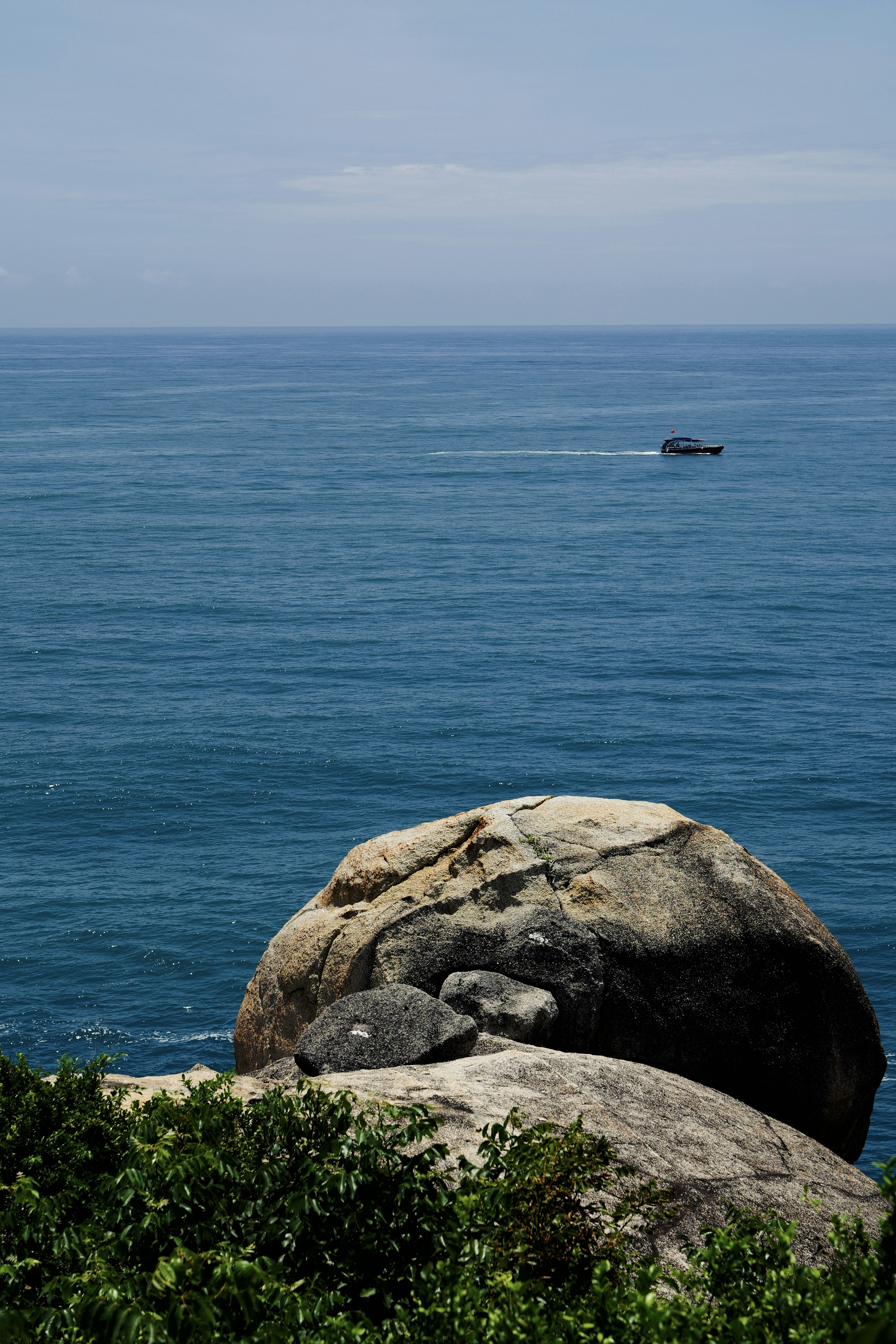 Coastal Serenity: A Lone Boat Glides Across a Quiet Horizon