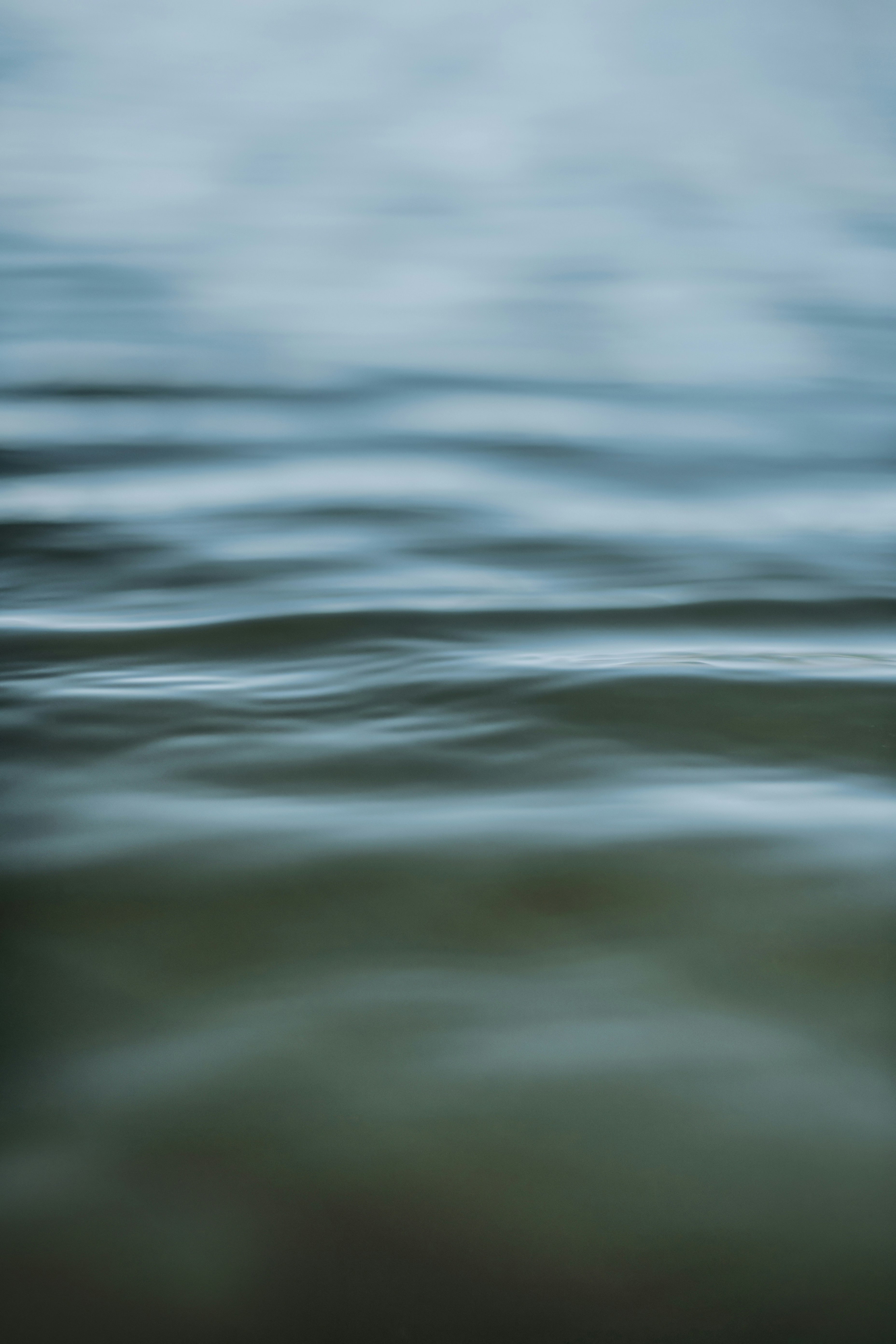 Soft ripples create delicate patterns on the surface of calm water.