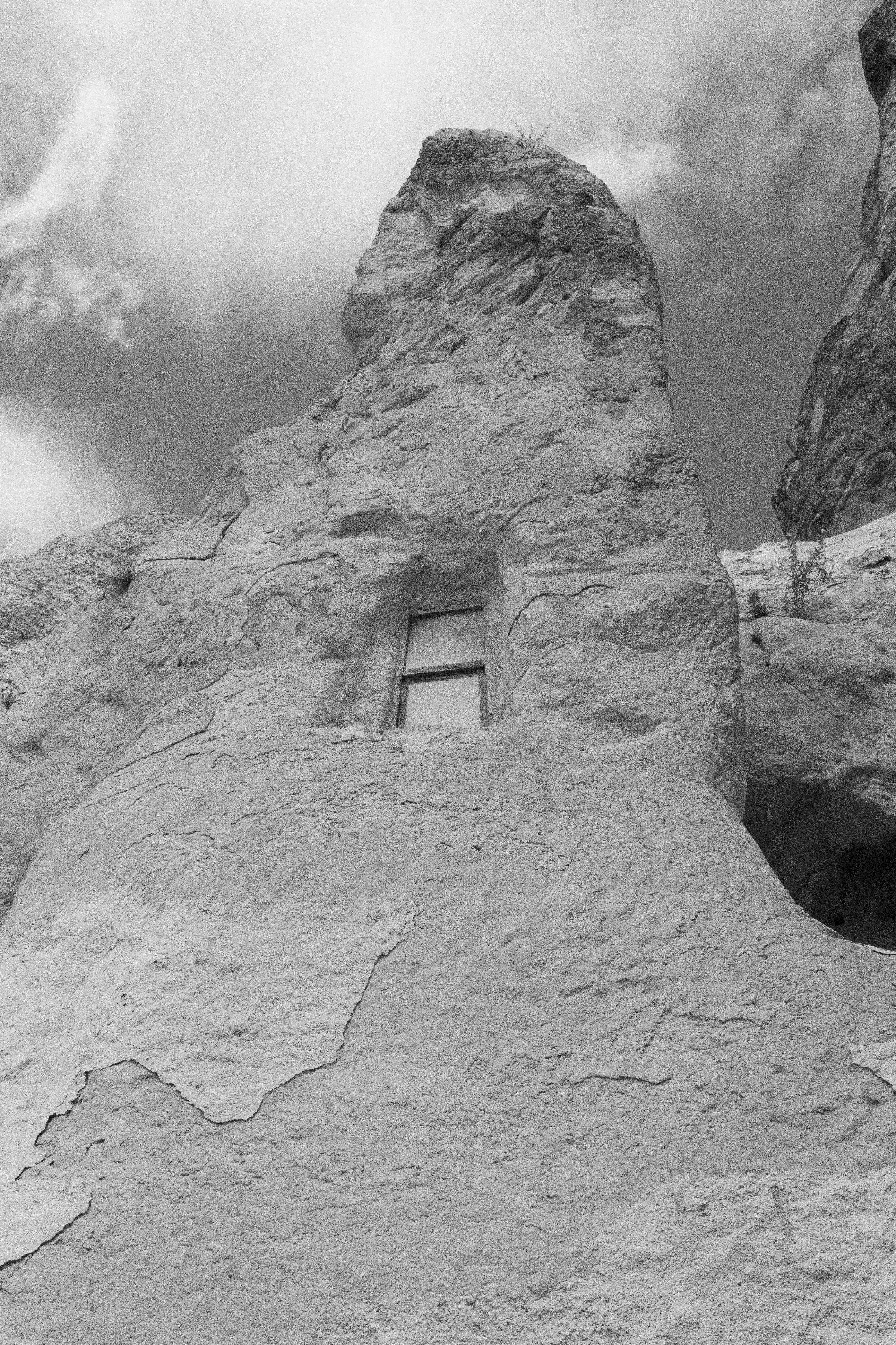 A Window Carved in a Weathered Cliff Face