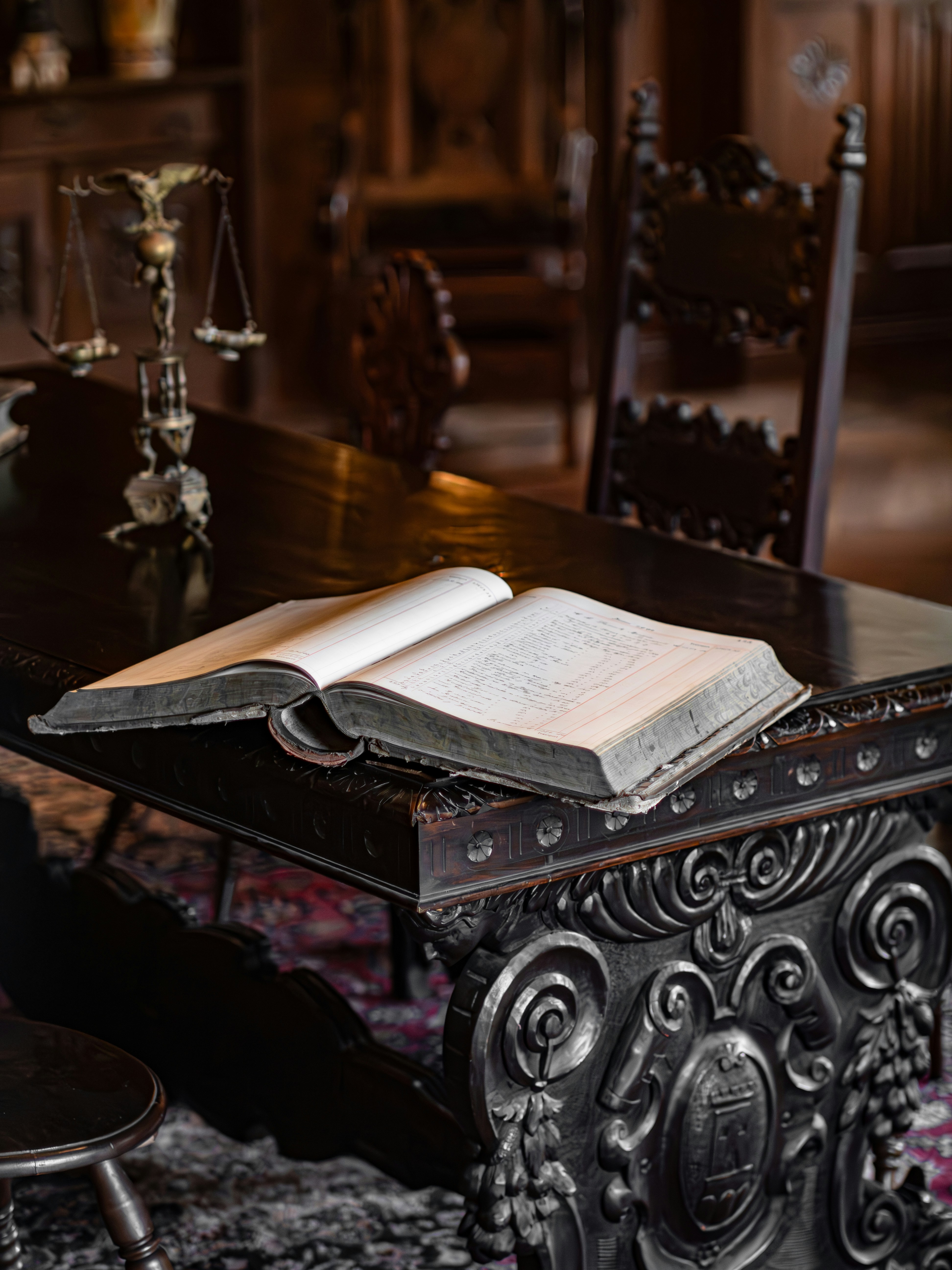 Open Ledger on a Carved Oak Table in a Dim Wood-Paneled Study