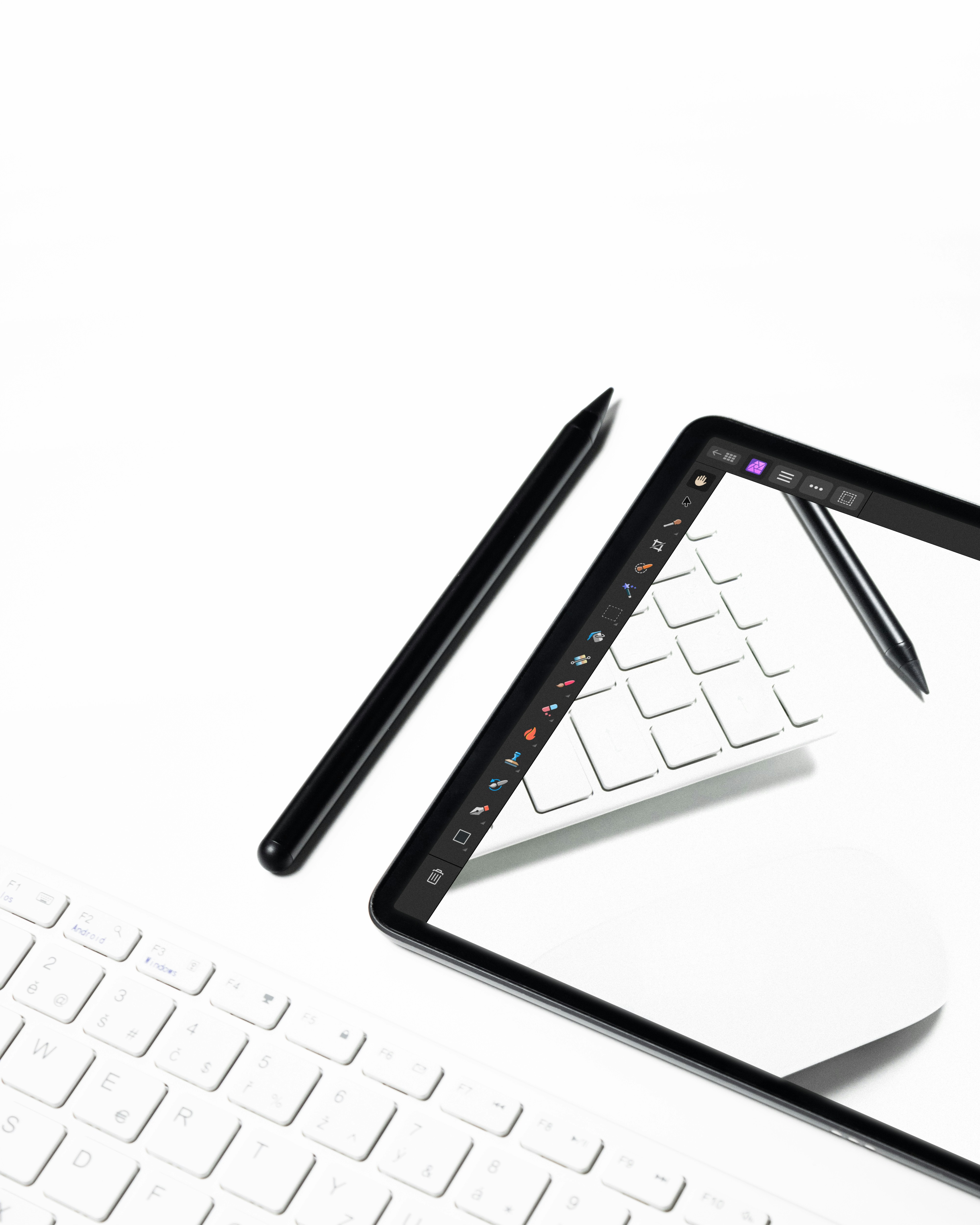 A tablet and a keyboard on a white surface photo – Free Office Image on ...