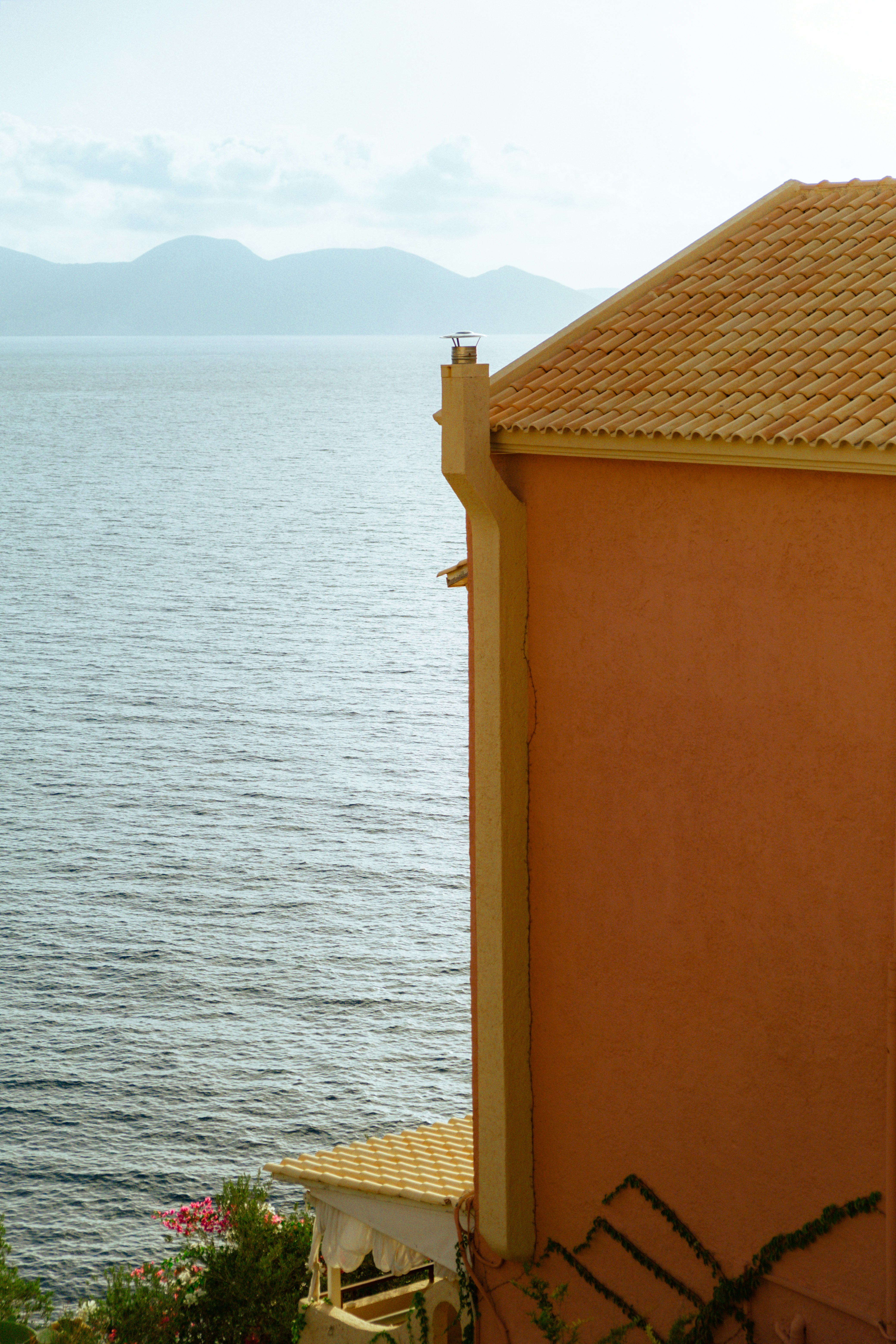 Terracotta Edge: A Seaside Villa Standing Against the Calm Horizon