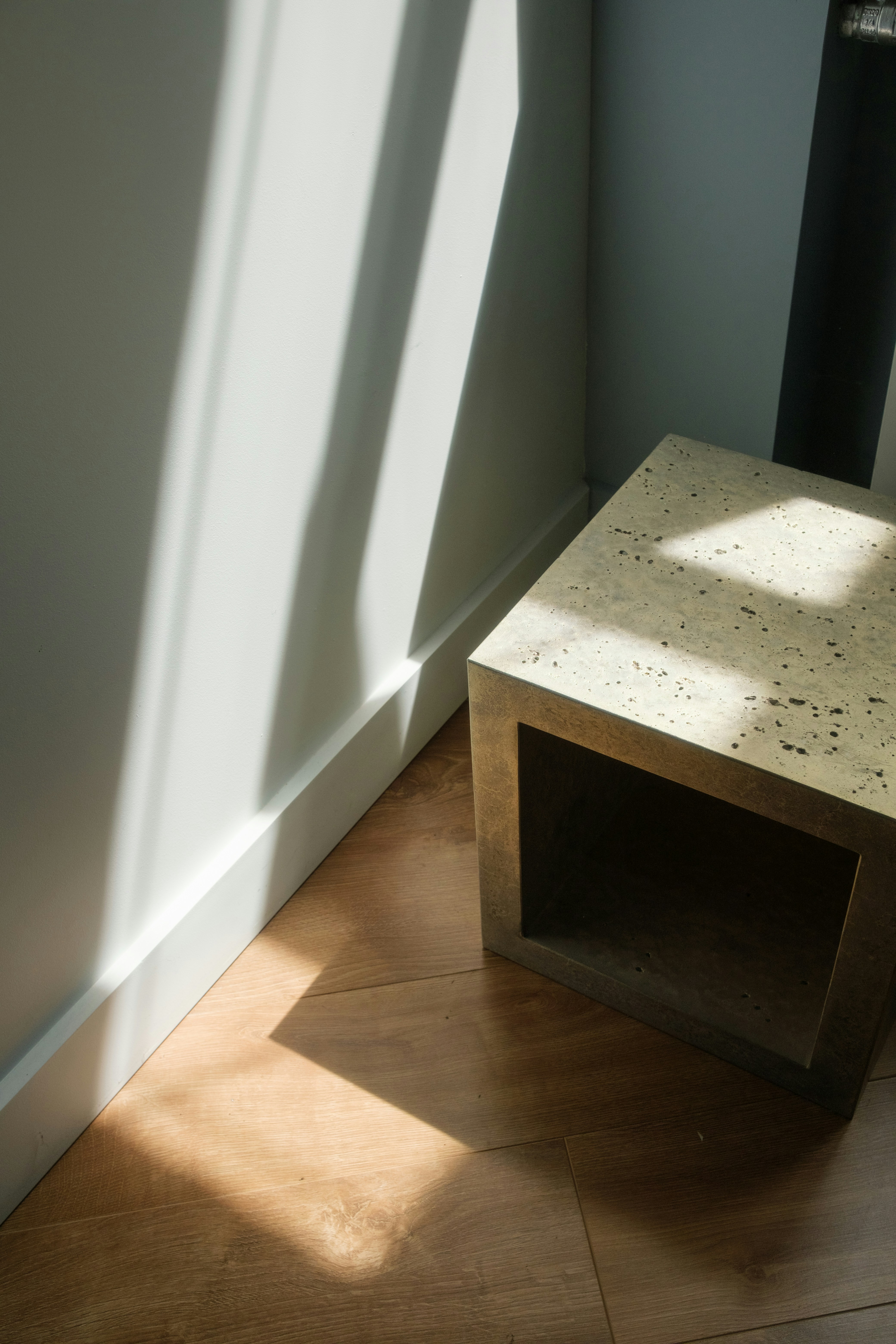 Quiet Geometry: Sunlit Corner with a Concrete Block