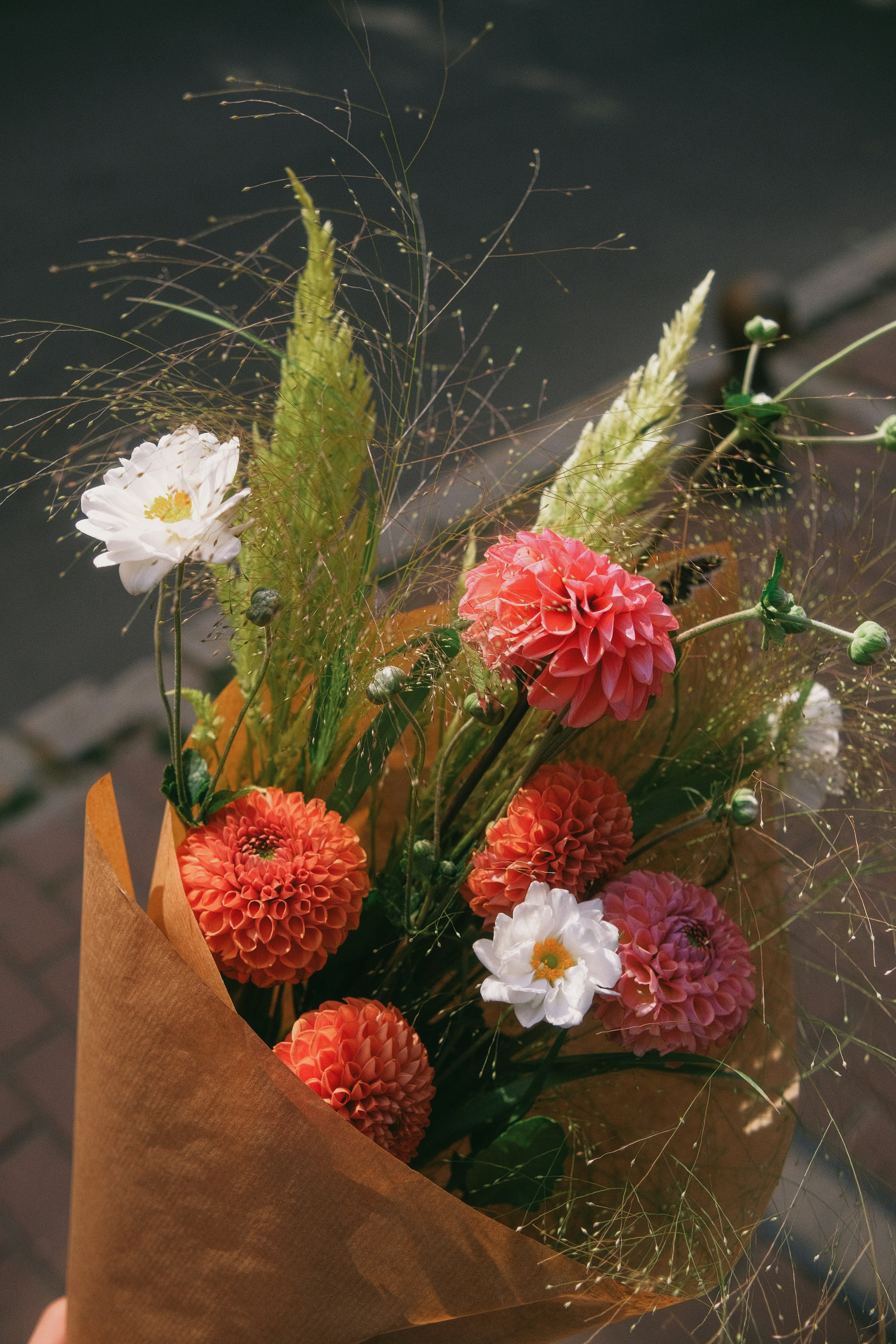 A person holding a bouquet of flowers in their hand