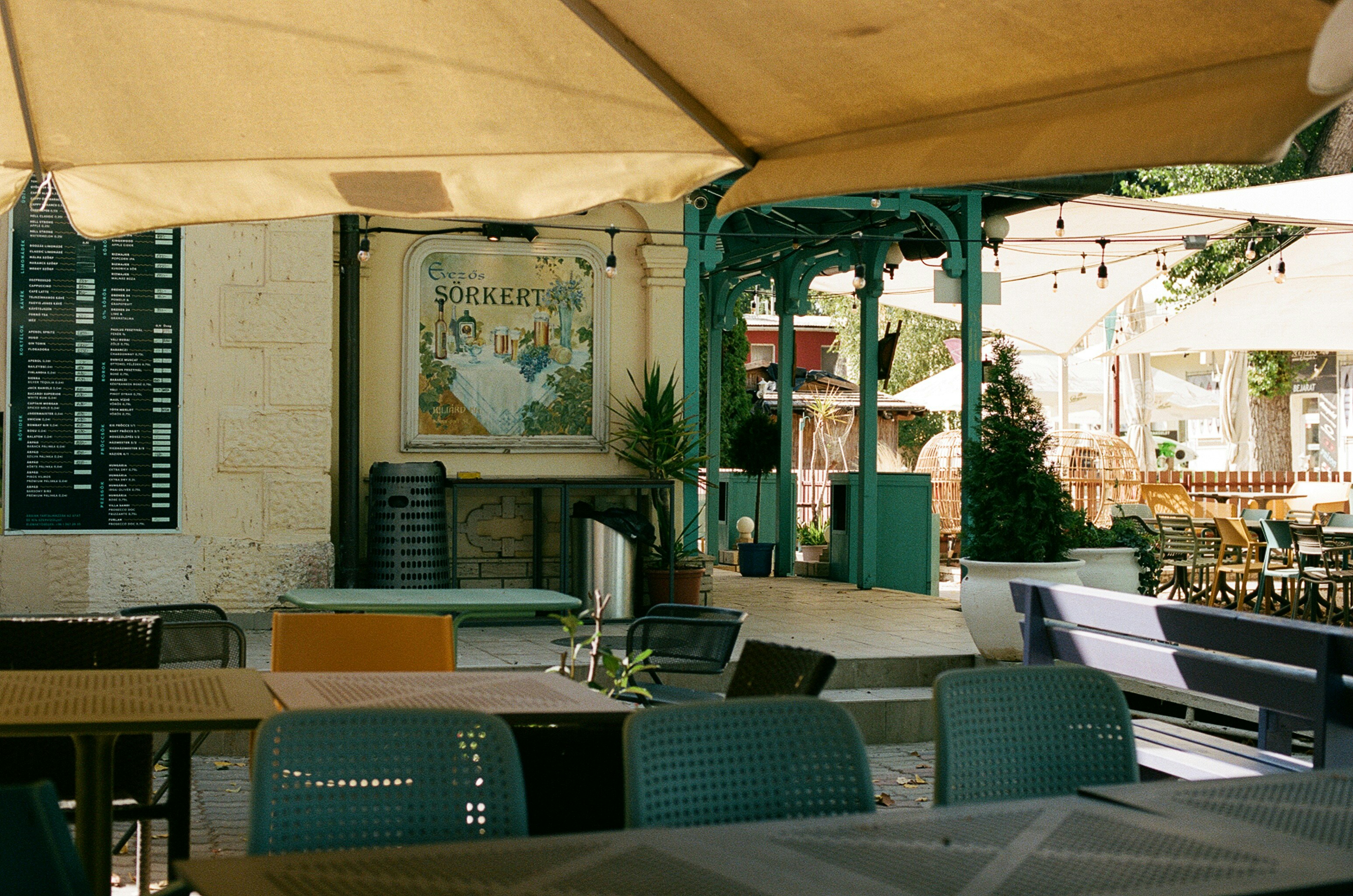 An outdoor dining area with tables and umbrellas photo – Free Budapest ...
