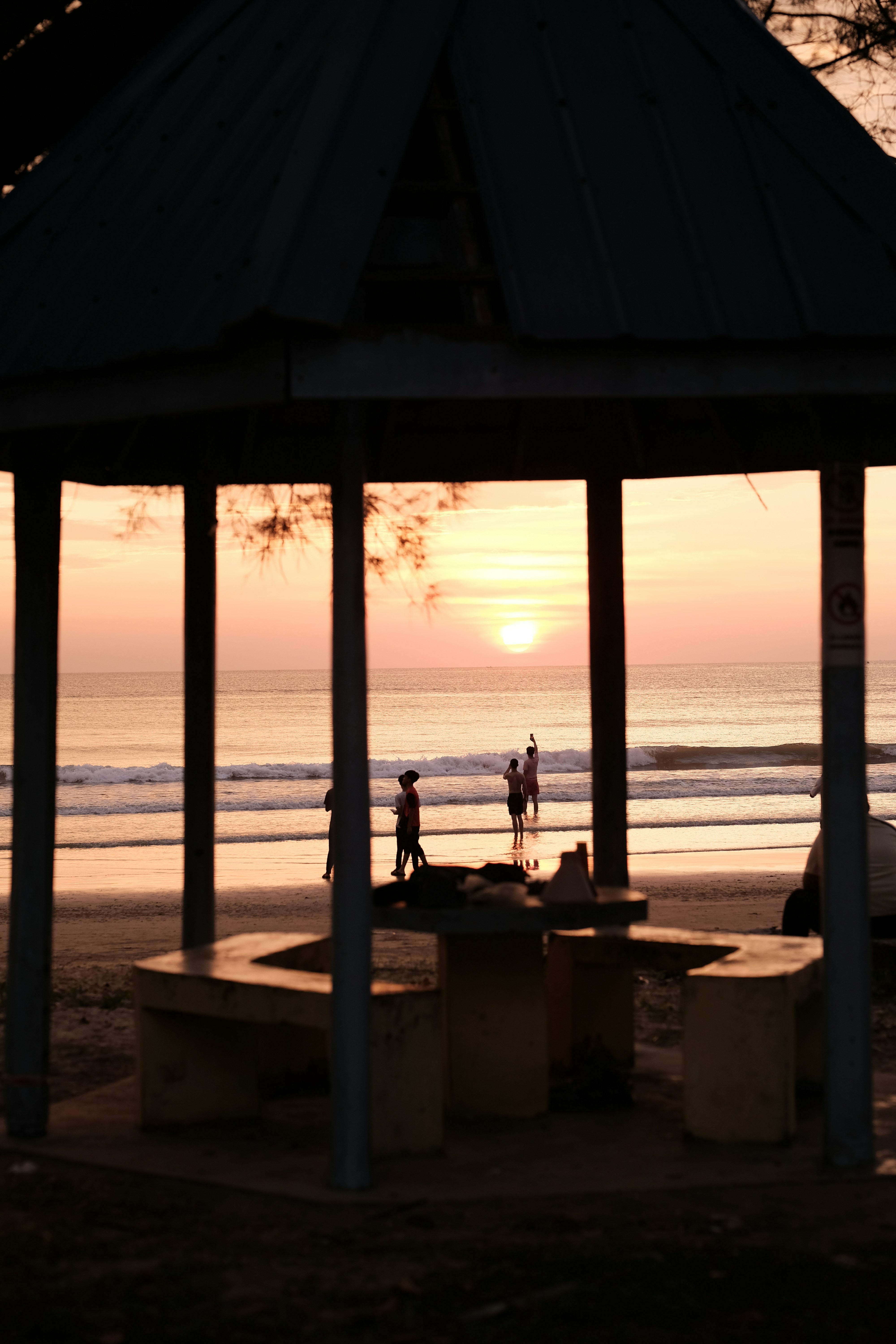 Sunset Silhouettes under a Pier Pavilion