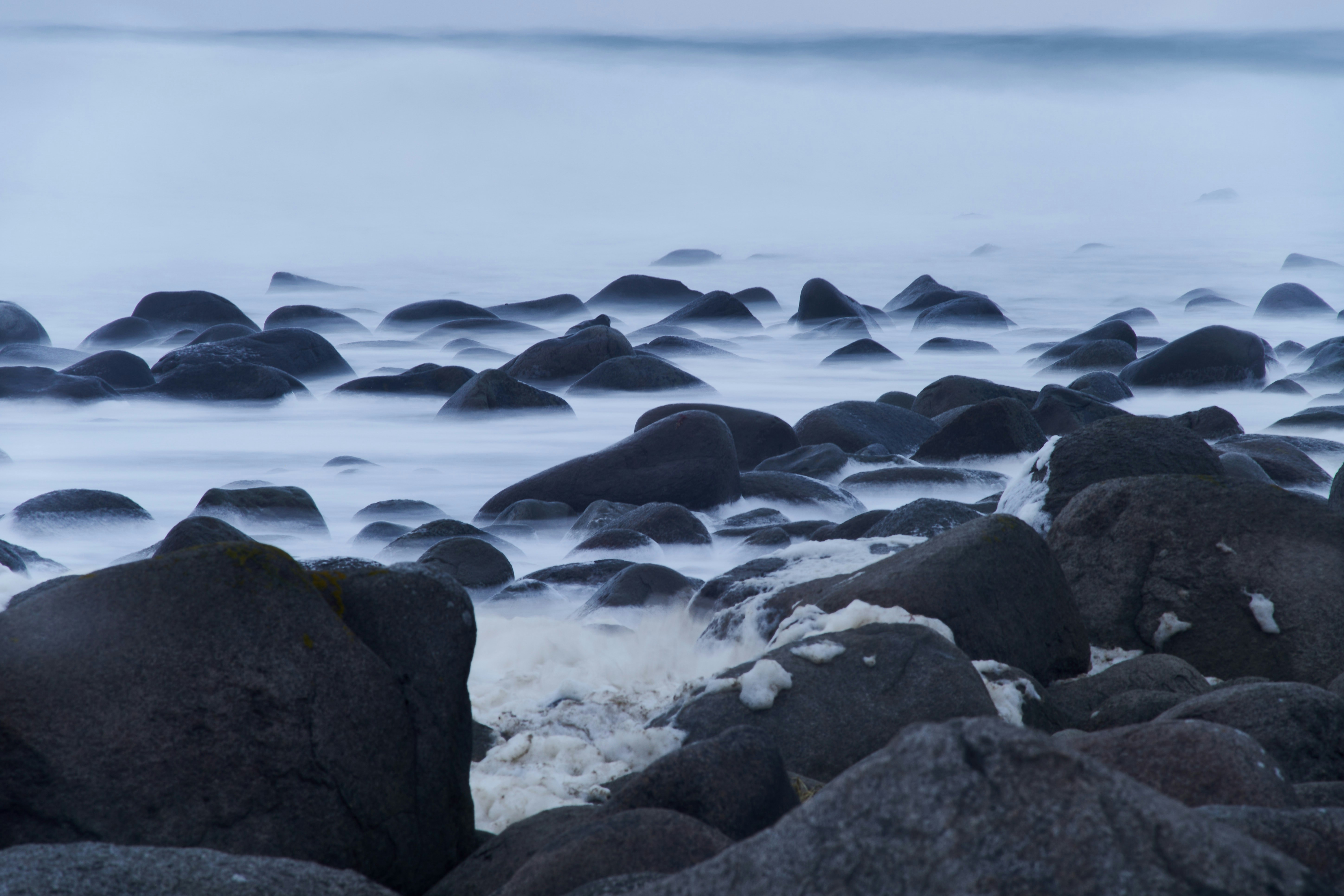 A group of rocks sitting on top of a beach photo – Free Rock Image on ...