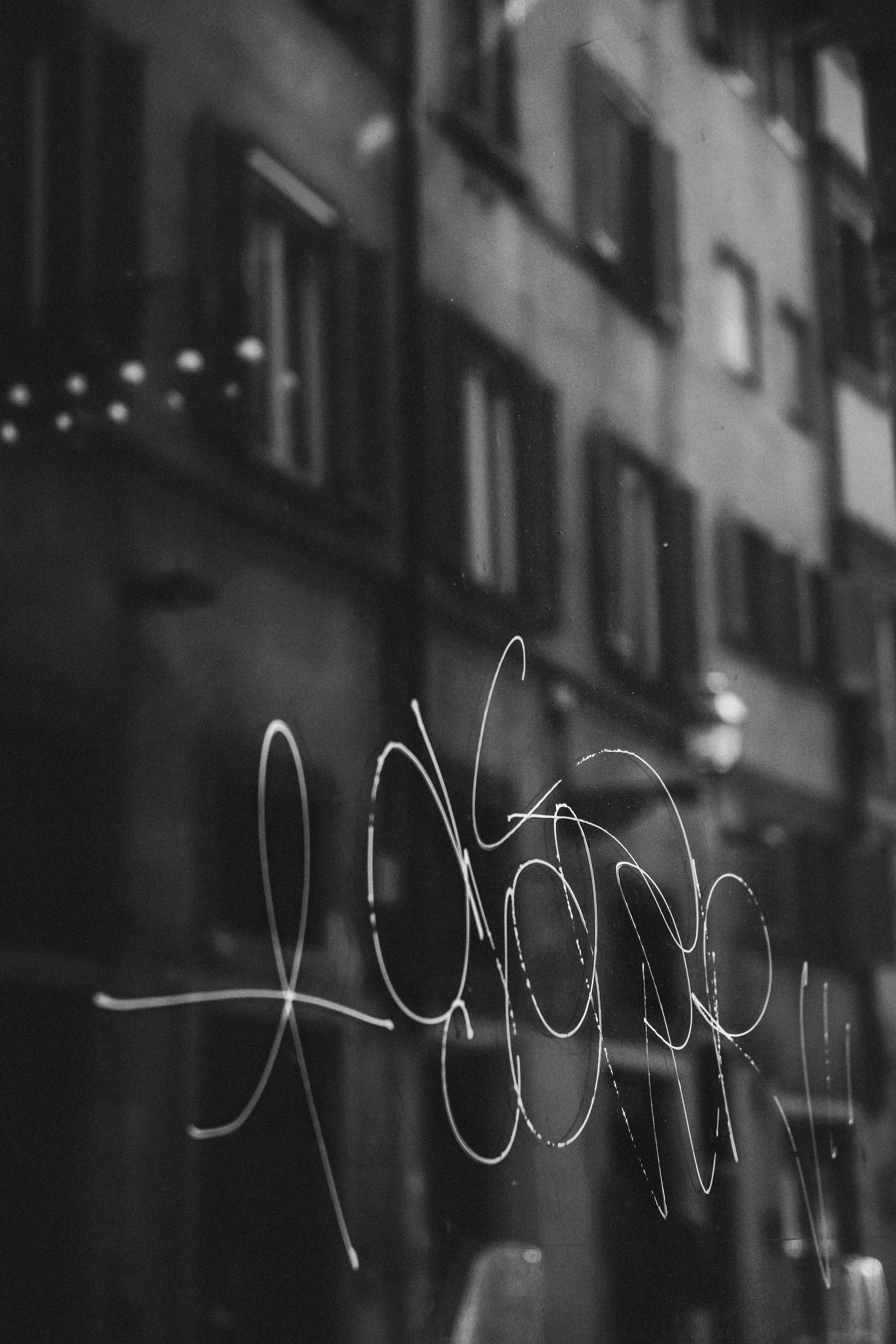 Graffiti Trails Across a Glass Facade