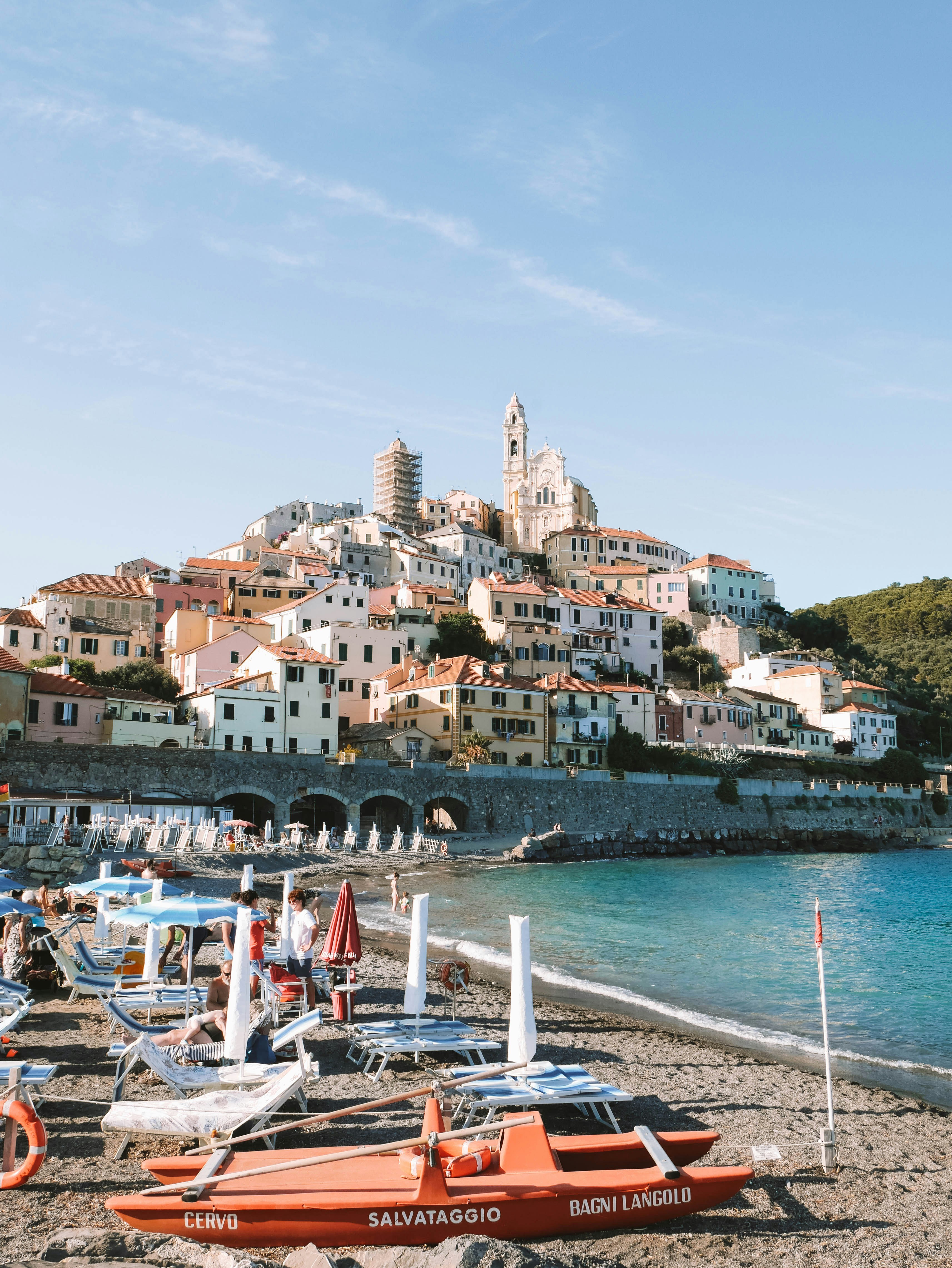 Cerulean Crest: A Sunlit Ligurian hillside town above a pebble beach
