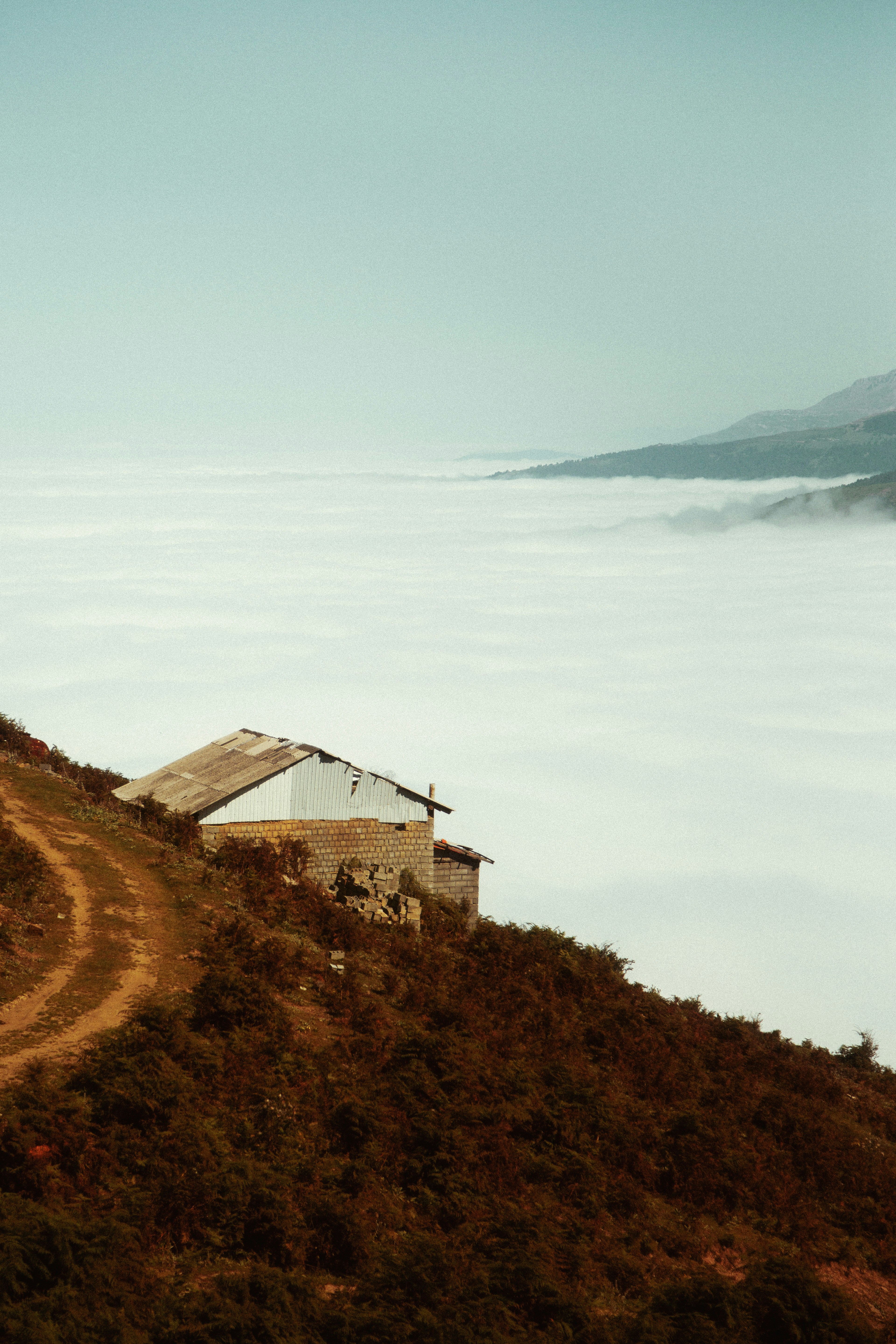 Ridge Cabin Bracing Against a Sea of Clouds at Dawn