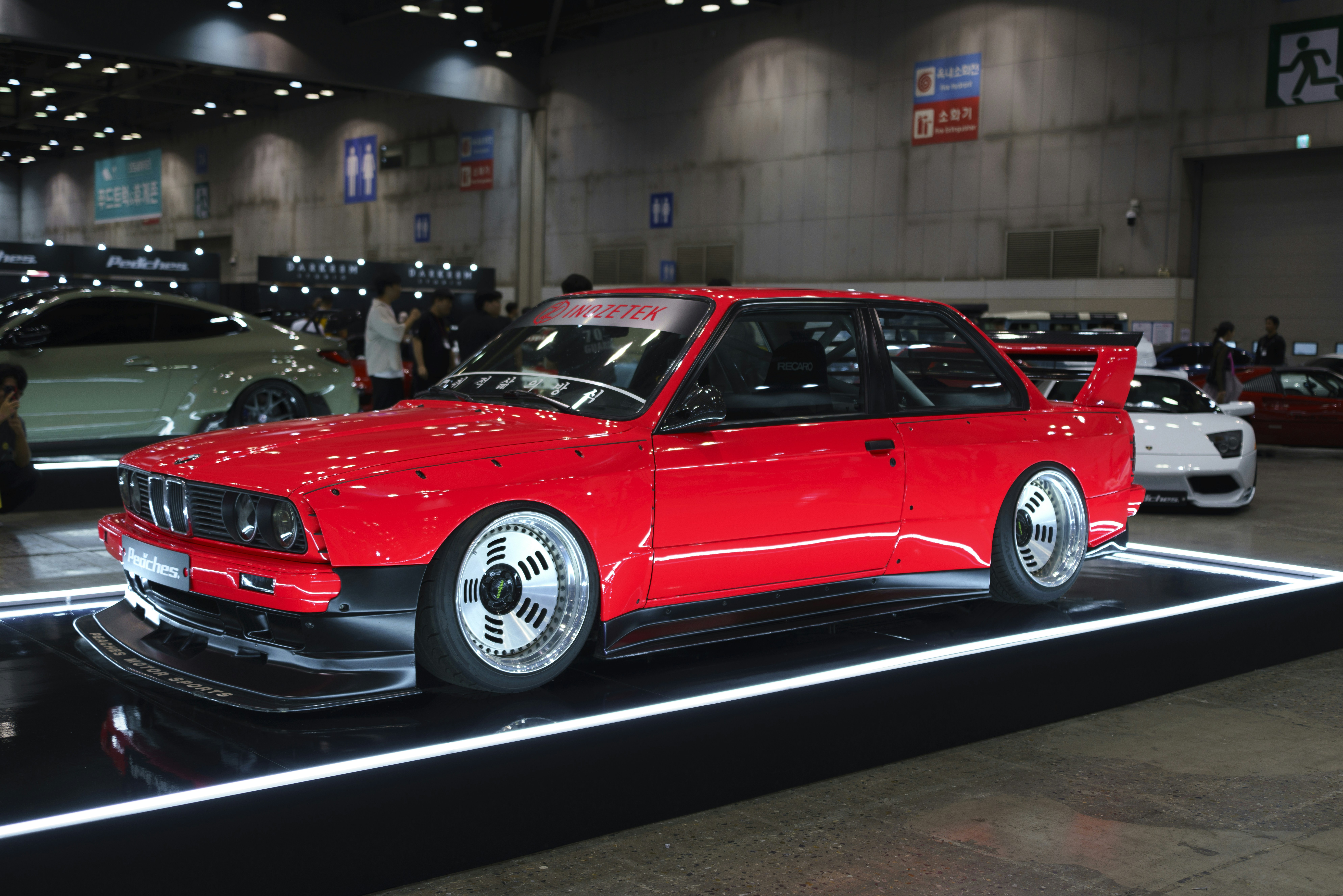 A red car on display at a car show photo – Free Car Image on Unsplash