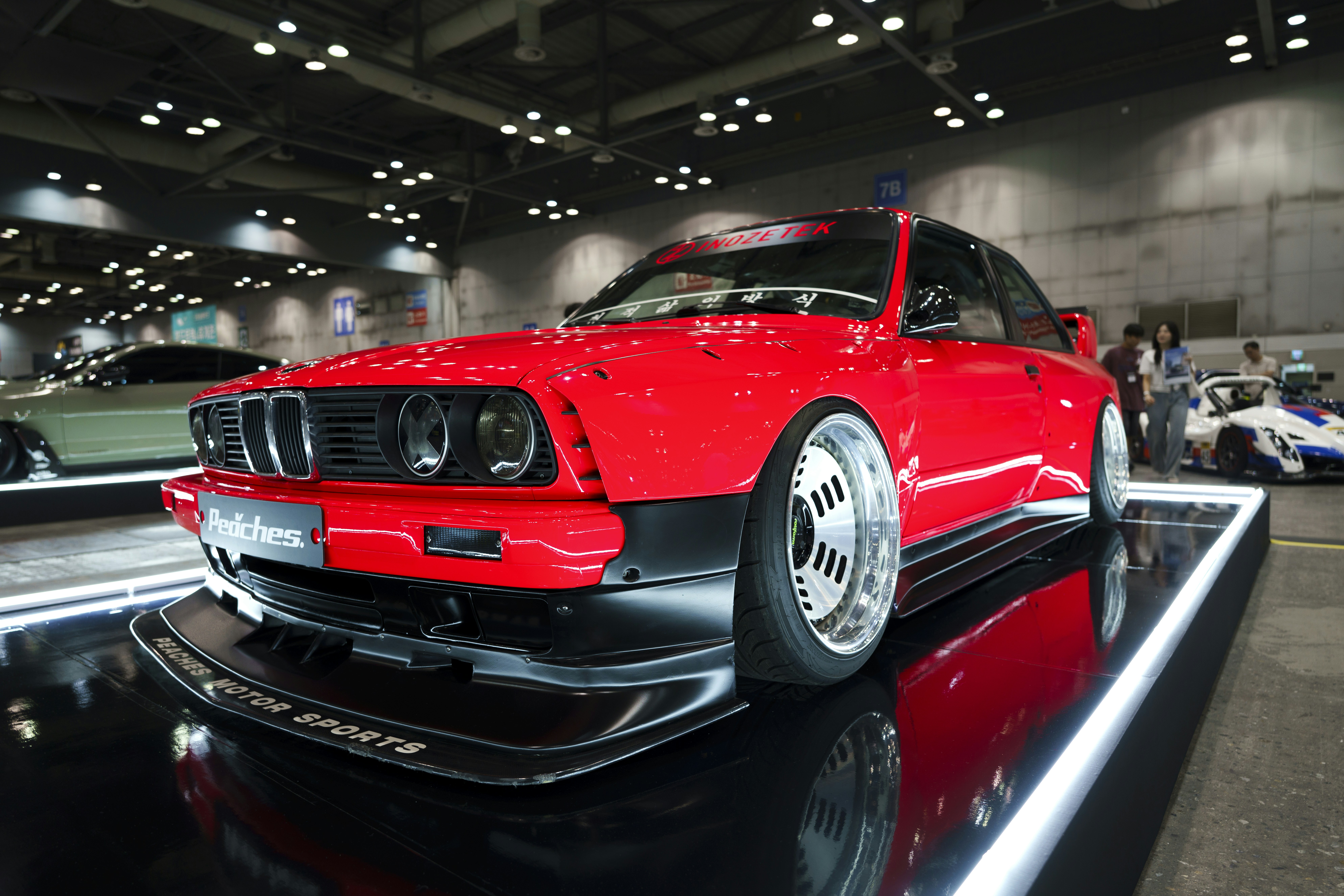 A red car on display at a car show photo – Free Car Image on Unsplash