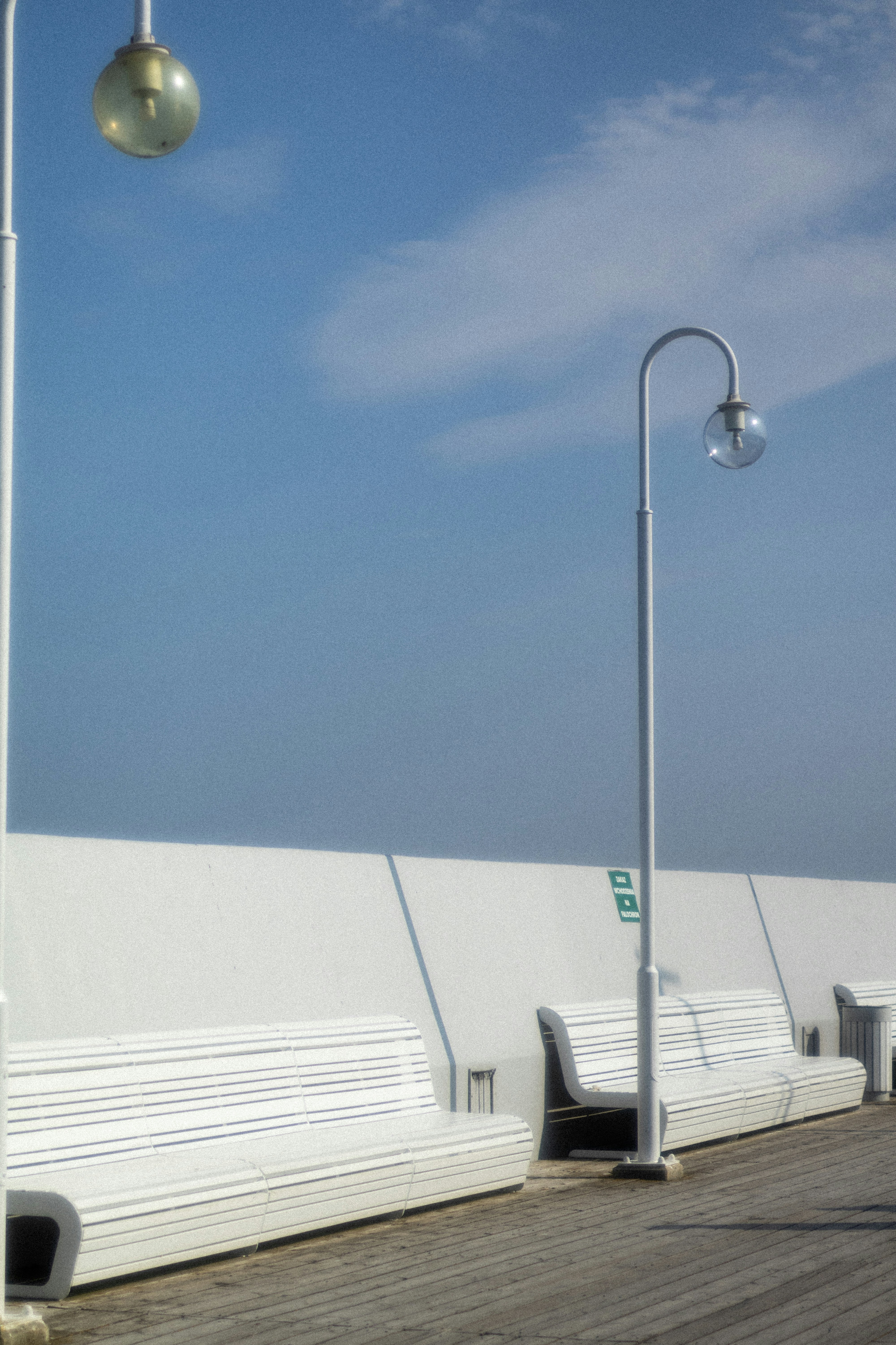 A row of benches sitting next to a street light photo – Free Lamp post ...