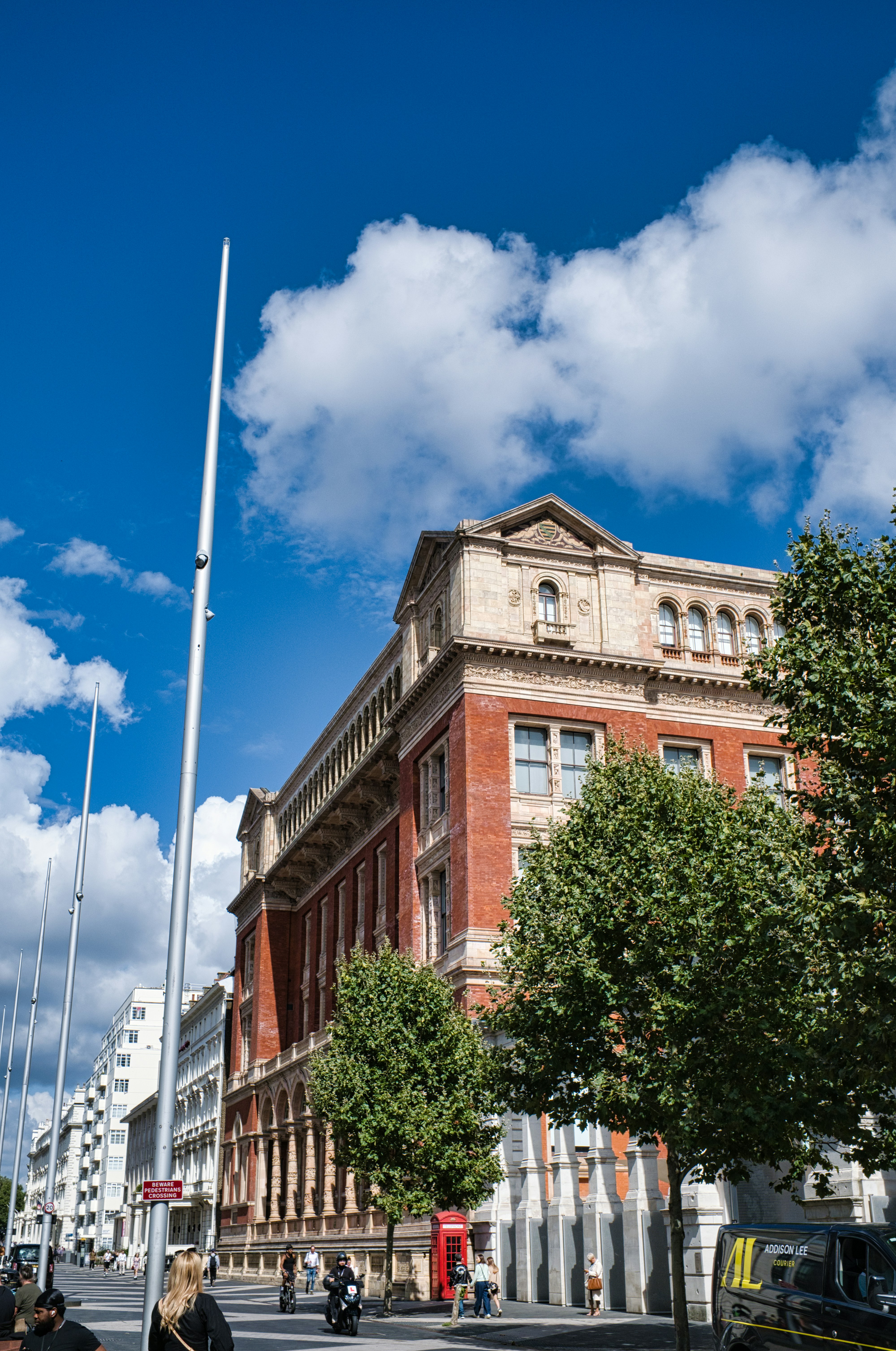 Red Brick Facade and Towering Streetline under a Blue Sky