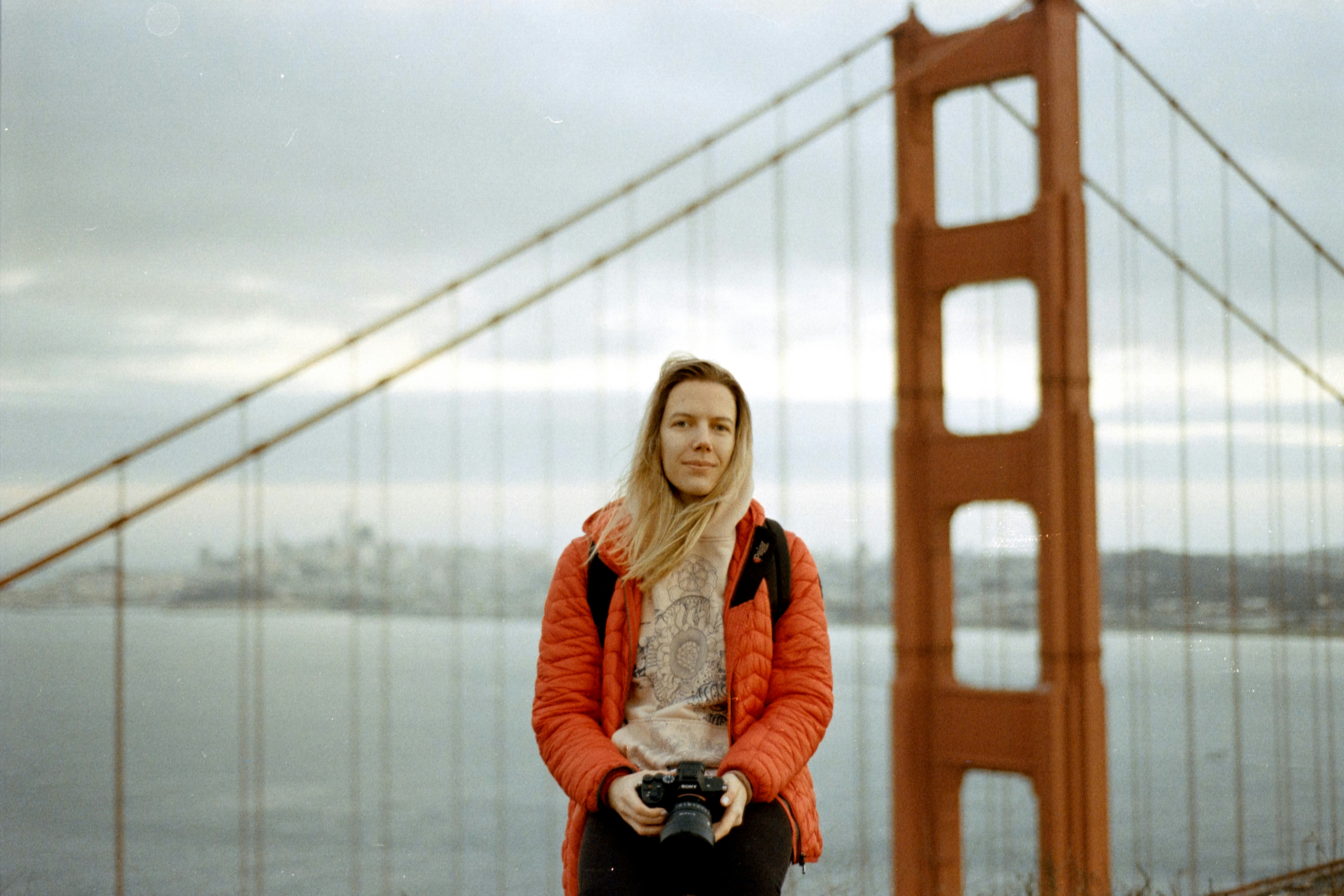 A woman standing in front of the golden gate bridge photo – Free San ...