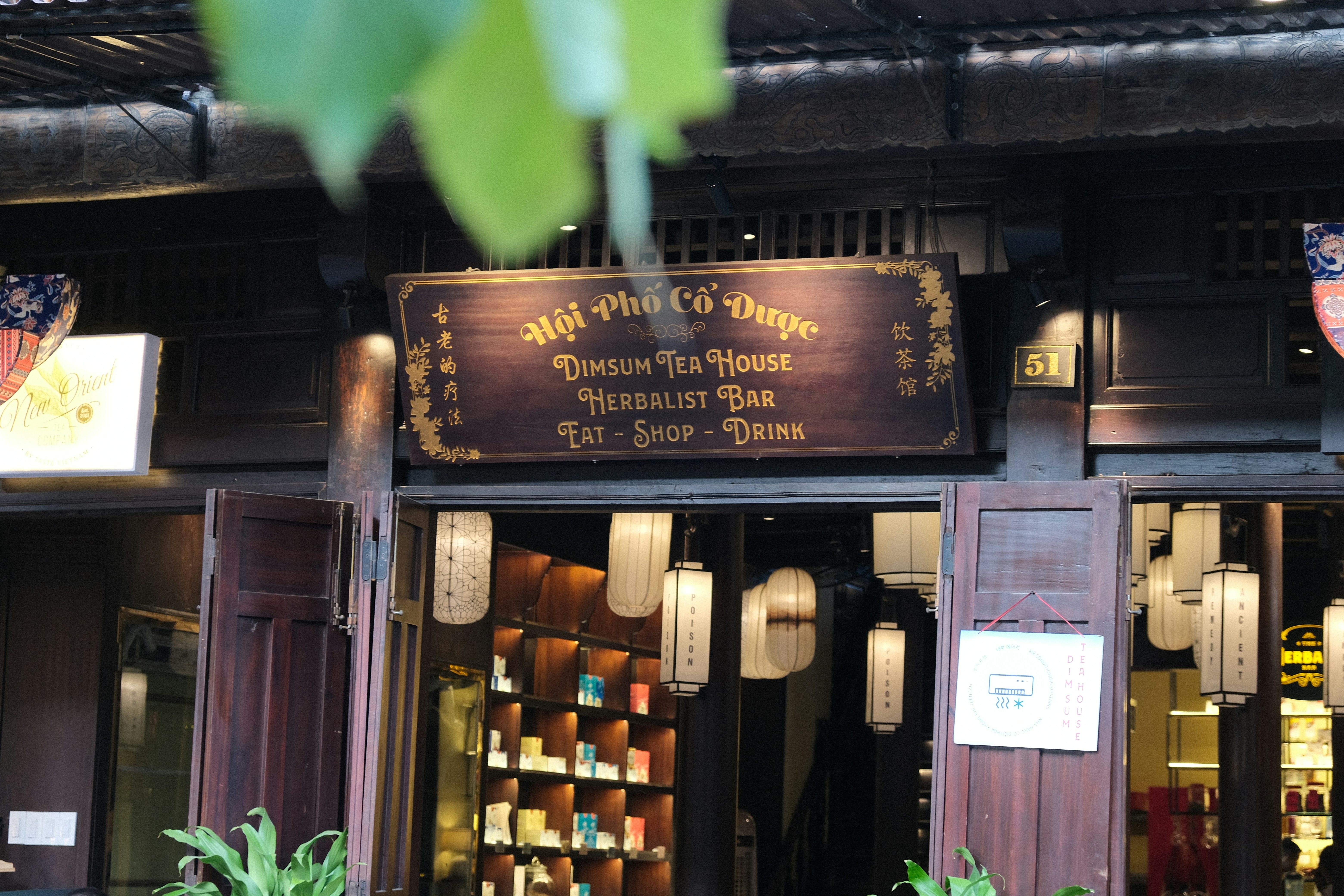 Lantern-Lit Dim Sum House: Open Doors, Warm Wood, Ornate Sign
