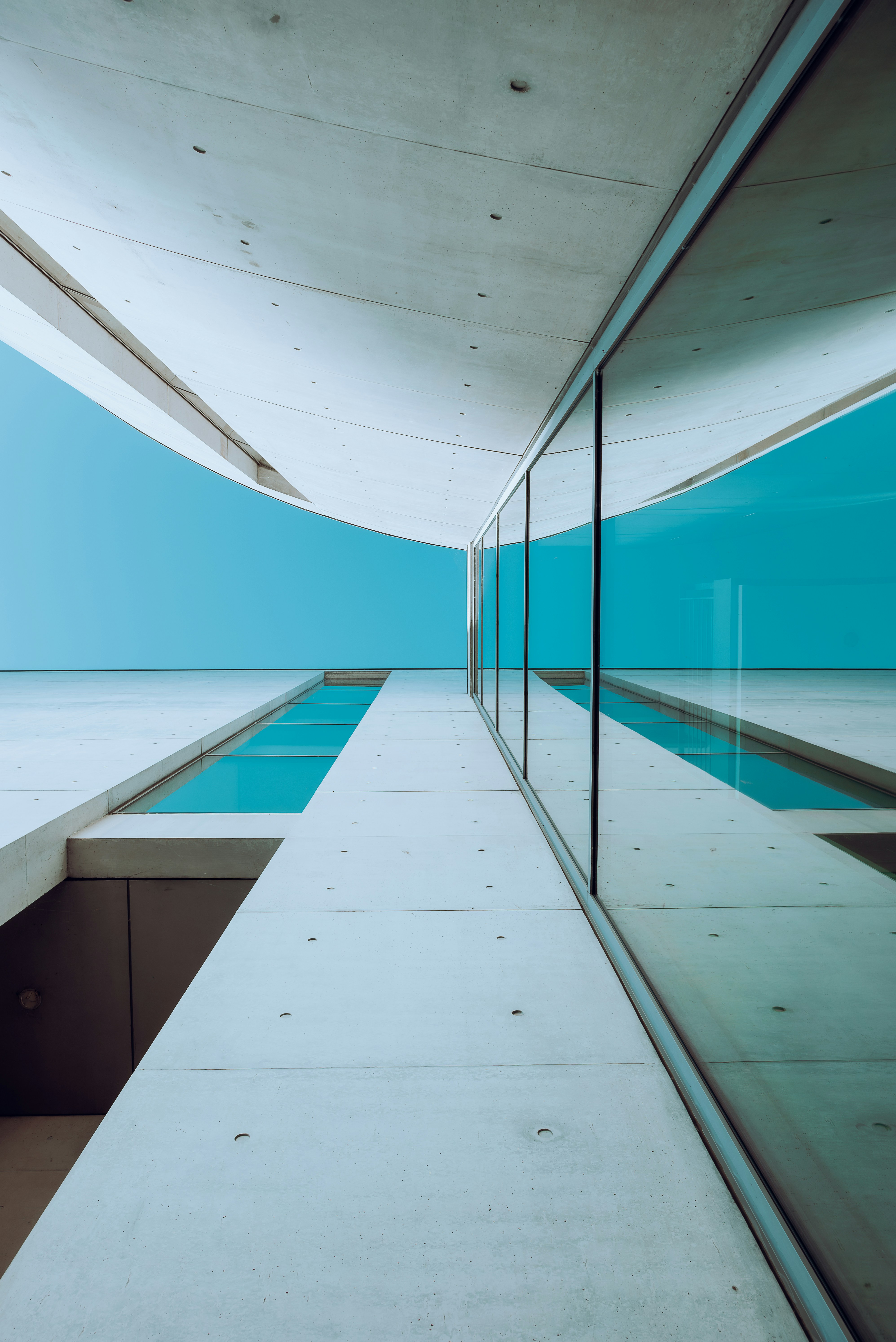 A long hallway with a view of a body of water photo – Free Berlin Image ...