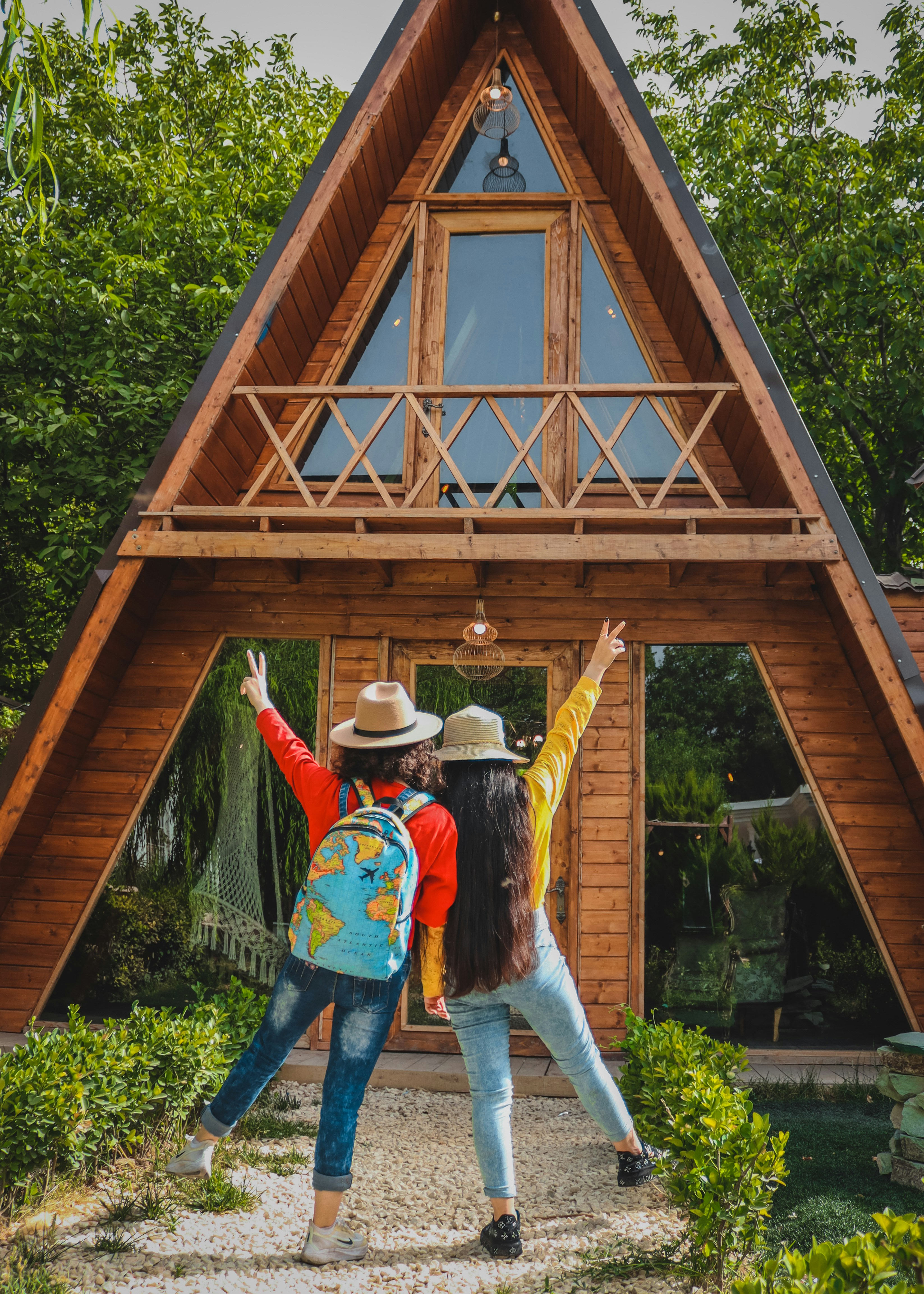 Two Adventurers Celebrate at the A-frame Cabin Entrance