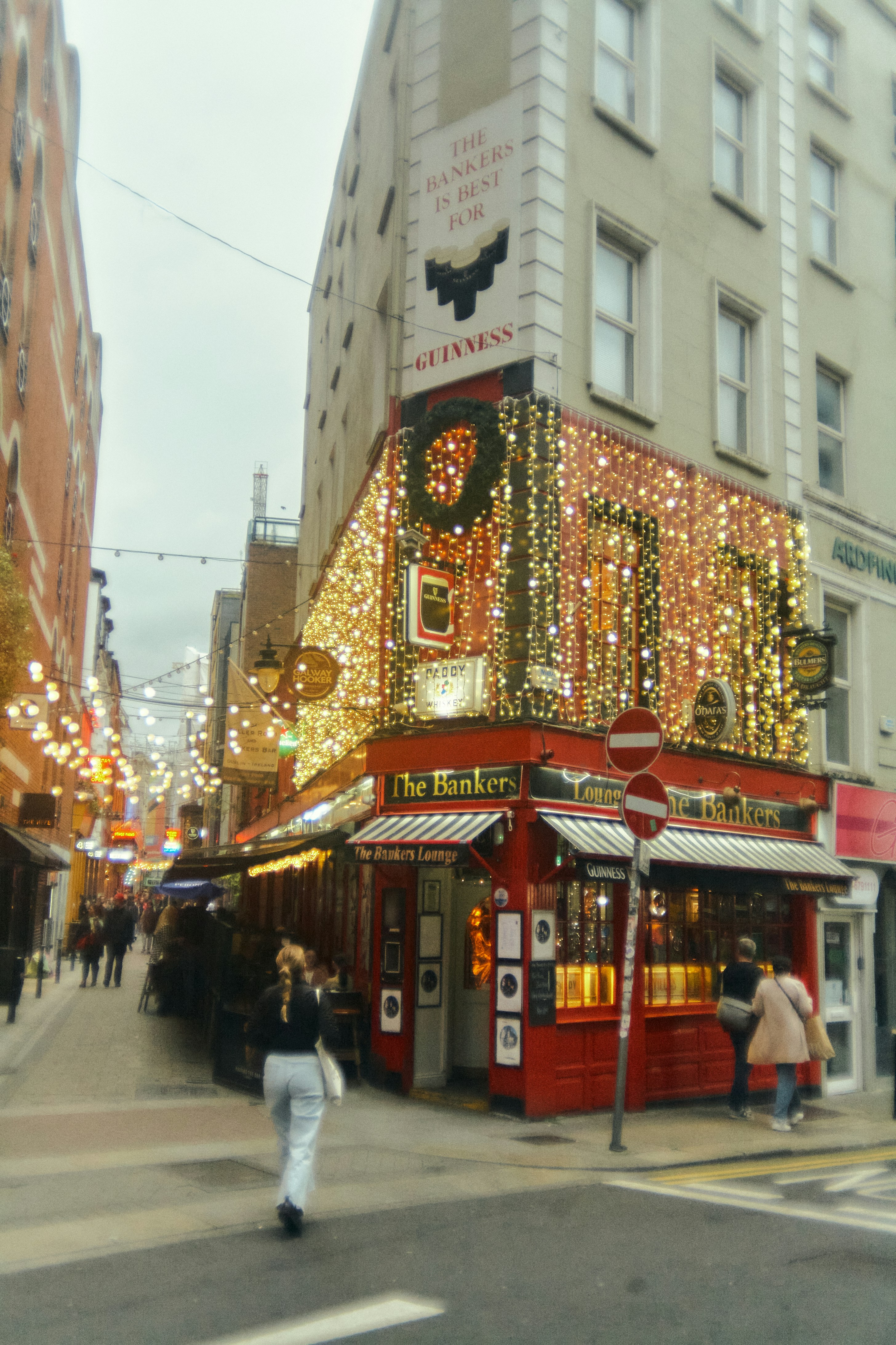 A street corner with a building covered in christmas lights photo ...