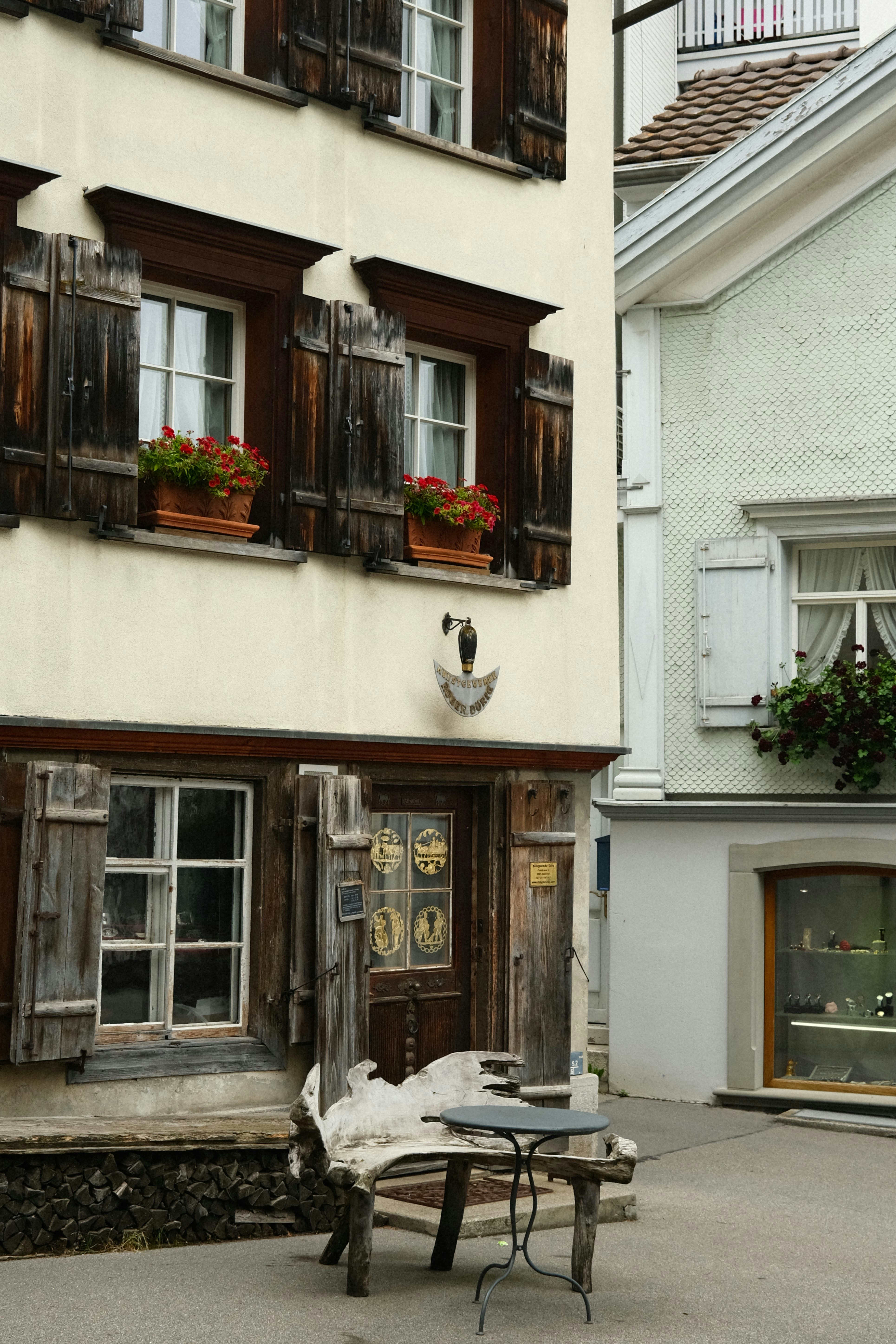 Old Town Facade with Flower Boxes and Weathered Shutters