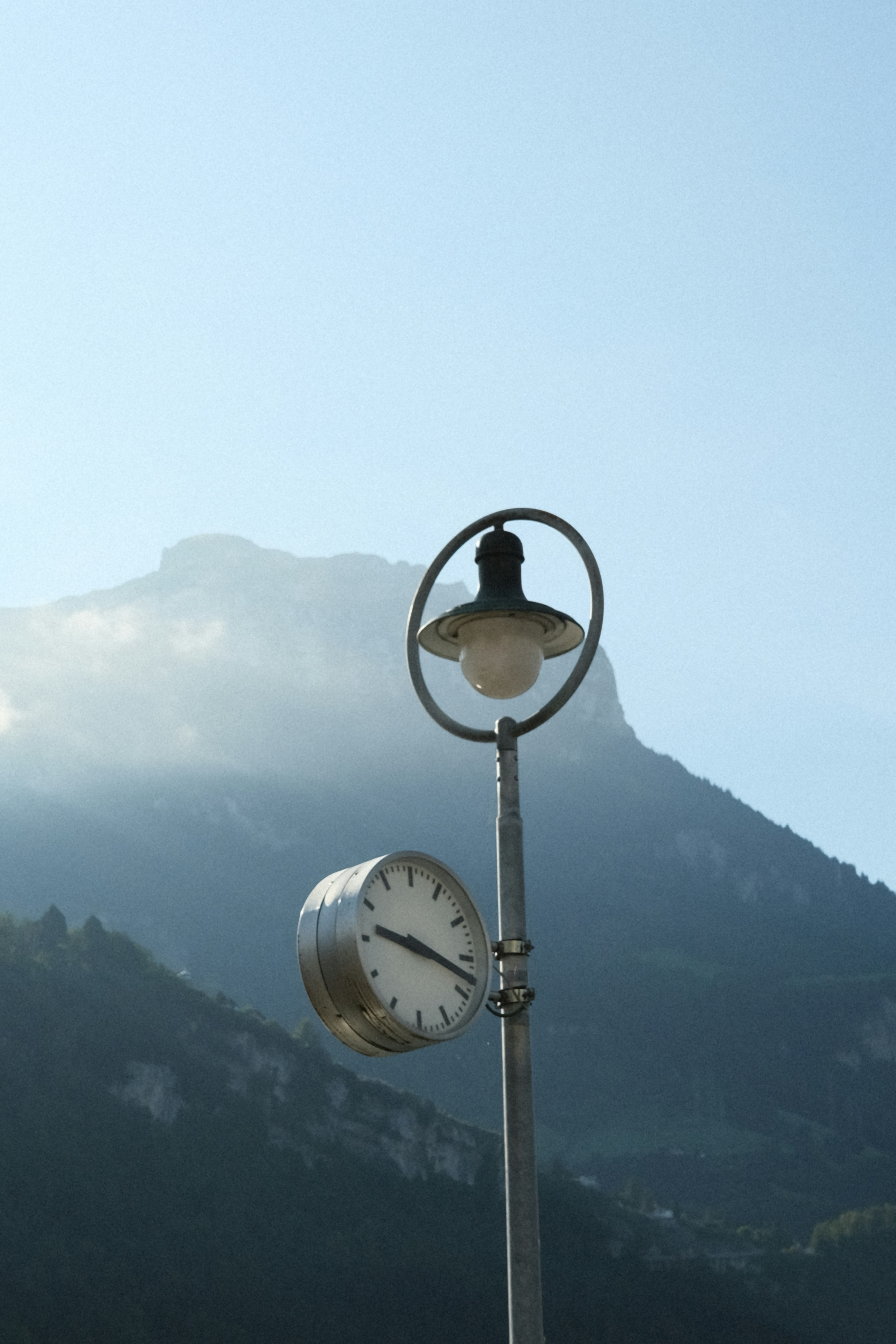 Lone Lamp with Clock Ring Over Quiet Alpine Ridge