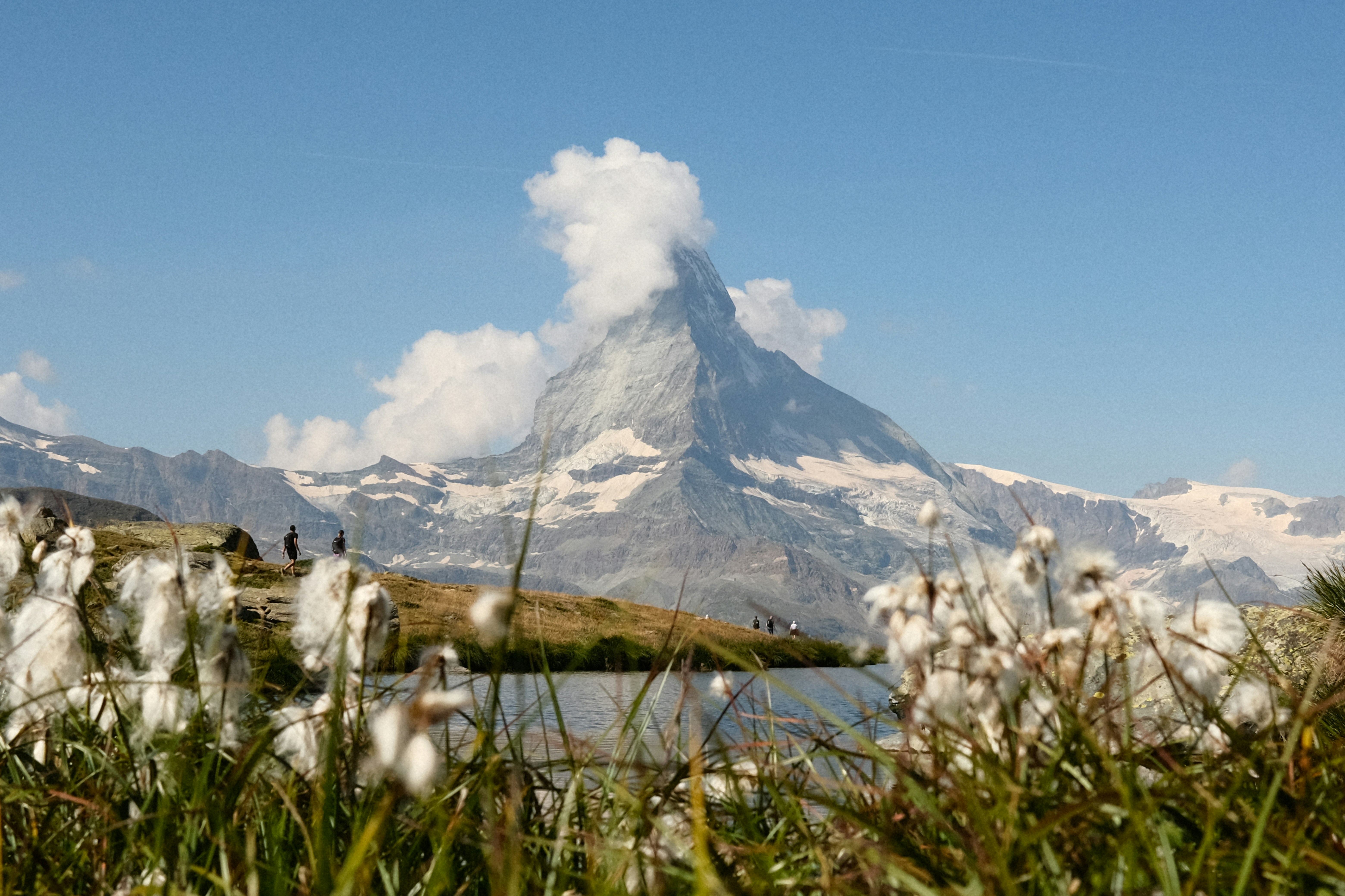 A view of a mountain with a lake in the foreground