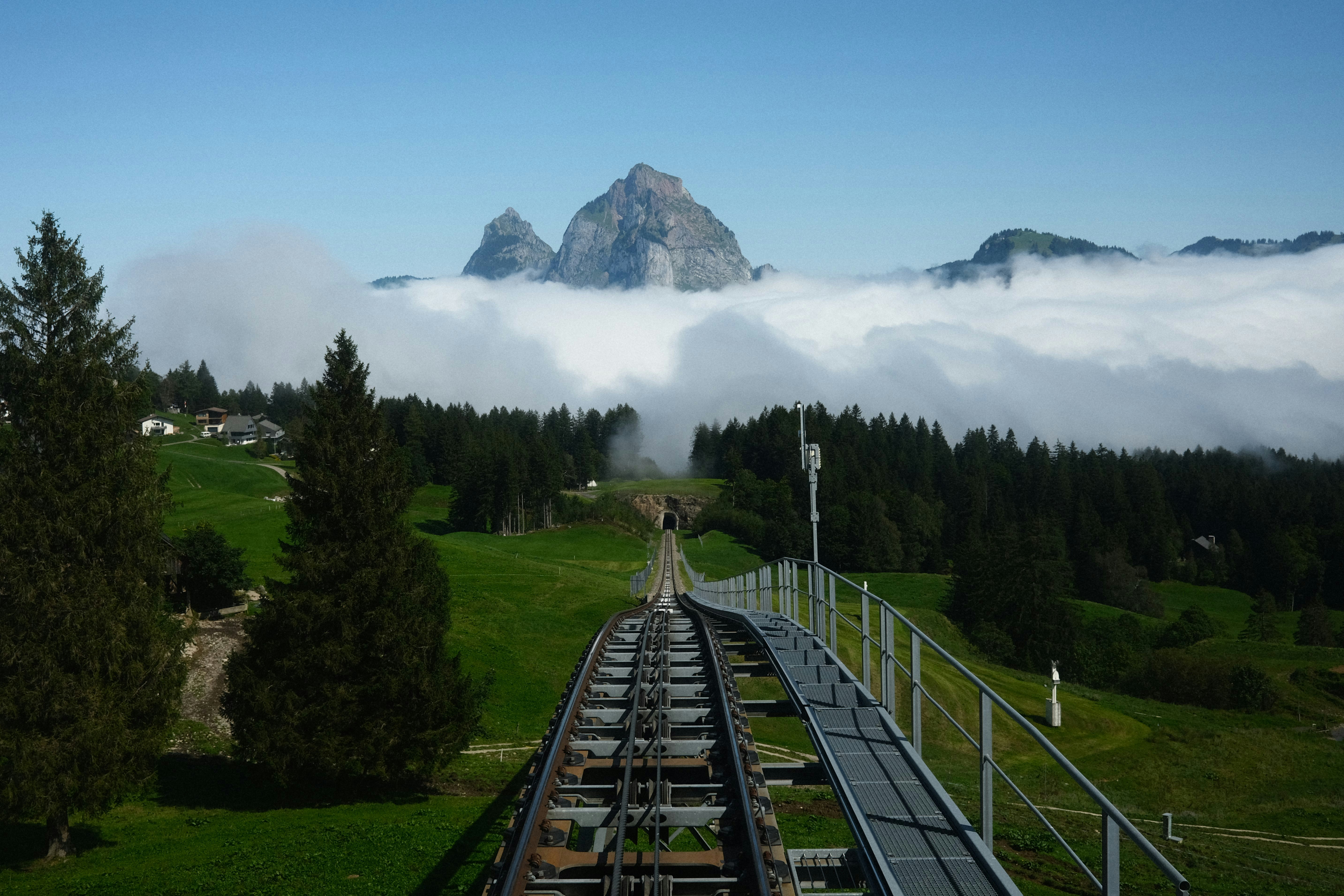 Cloudbound Rails: A Quiet Descent Through Alpine Green