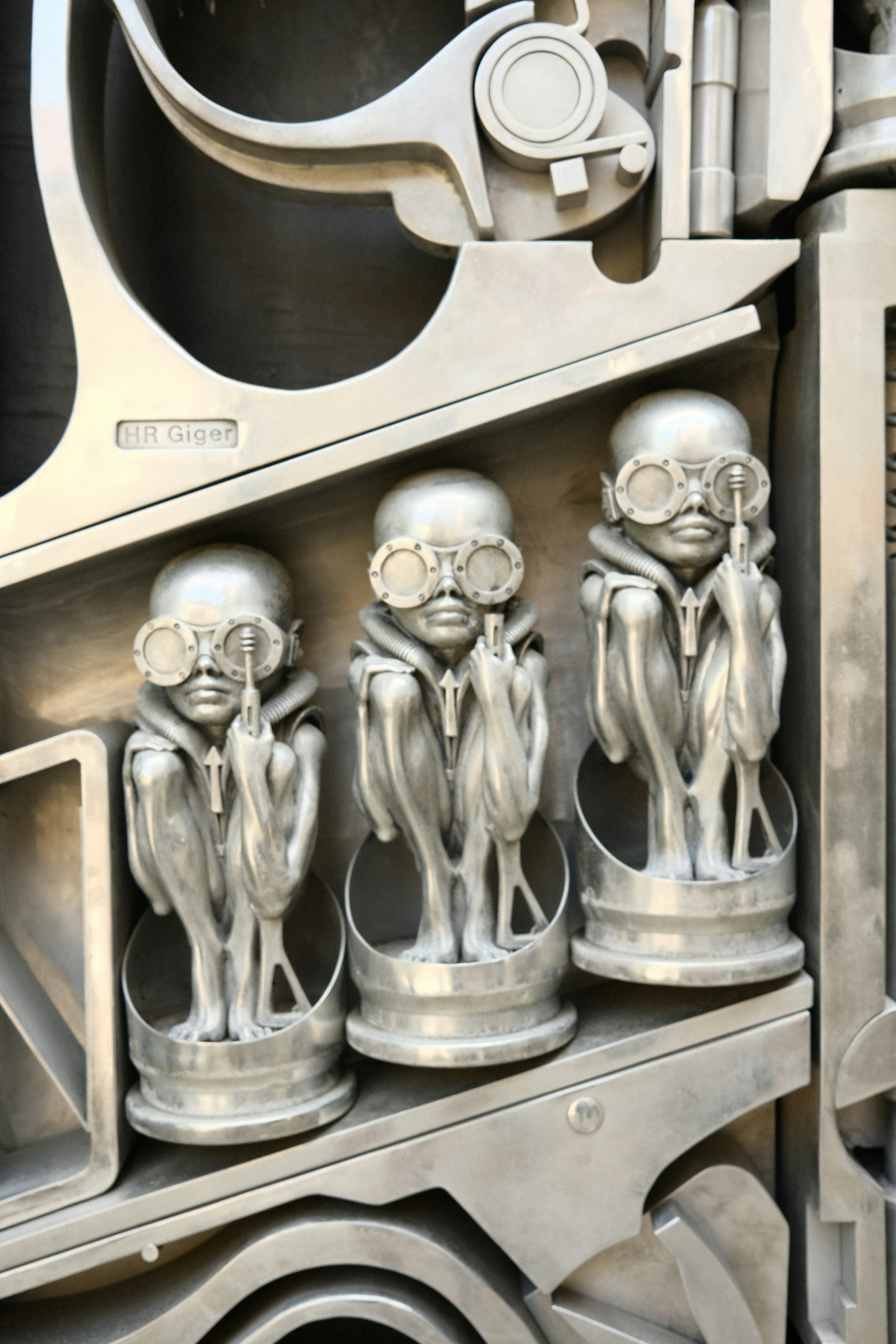 A group of metal sculptures sitting on top of a shelf