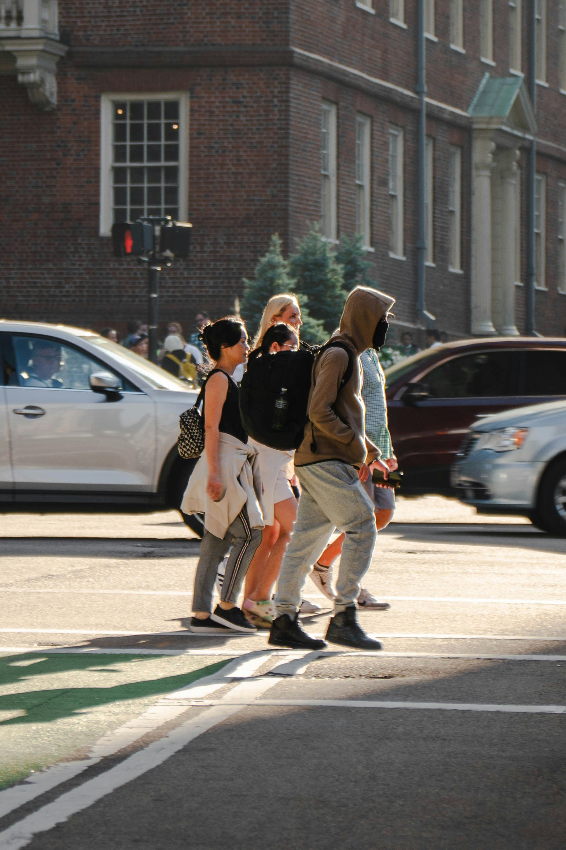 Crosswalk Ensemble: Sunlit Pedestrians Navigate a Busy City Street