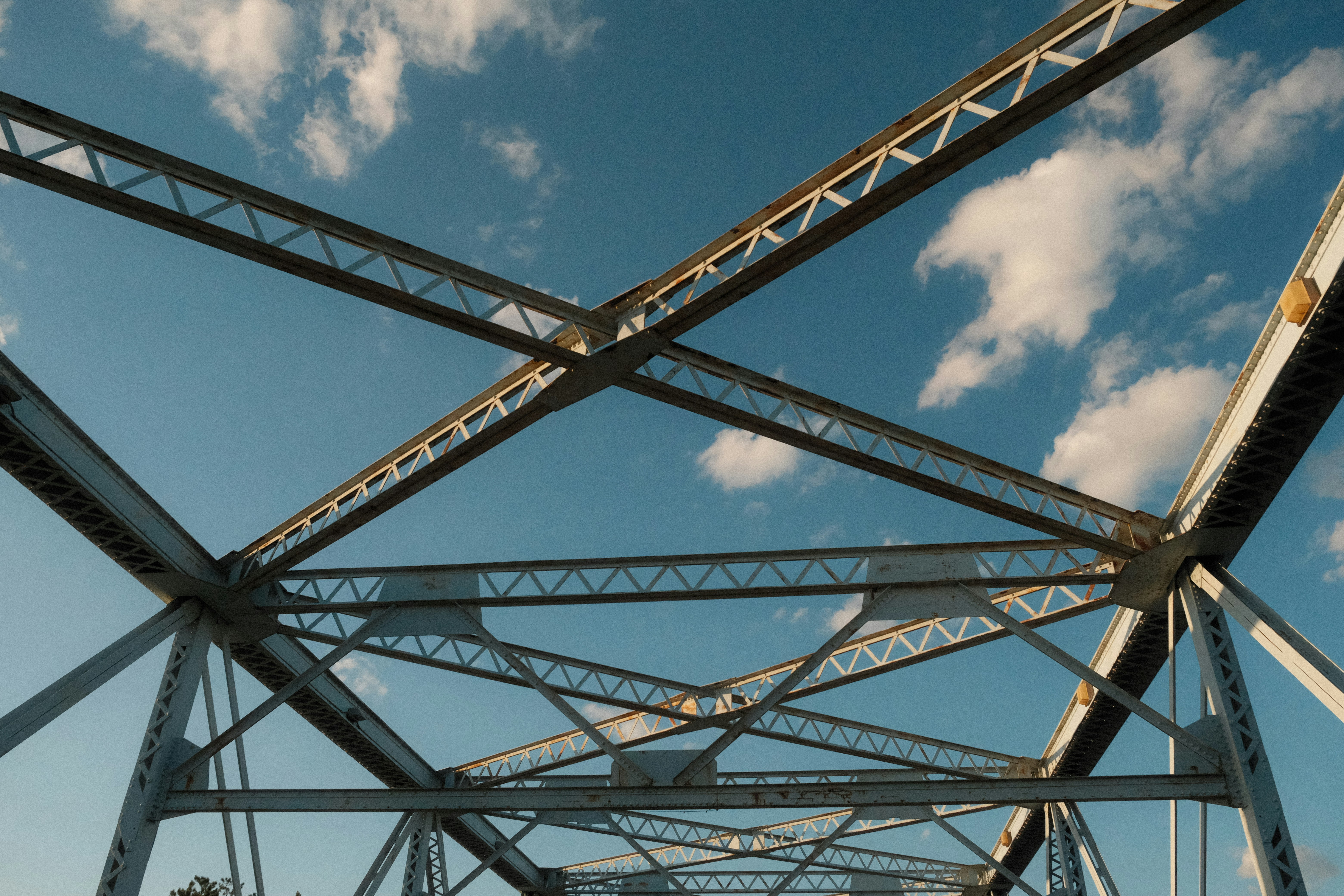 A train traveling over a bridge under a blue sky photo – Free Spokane ...